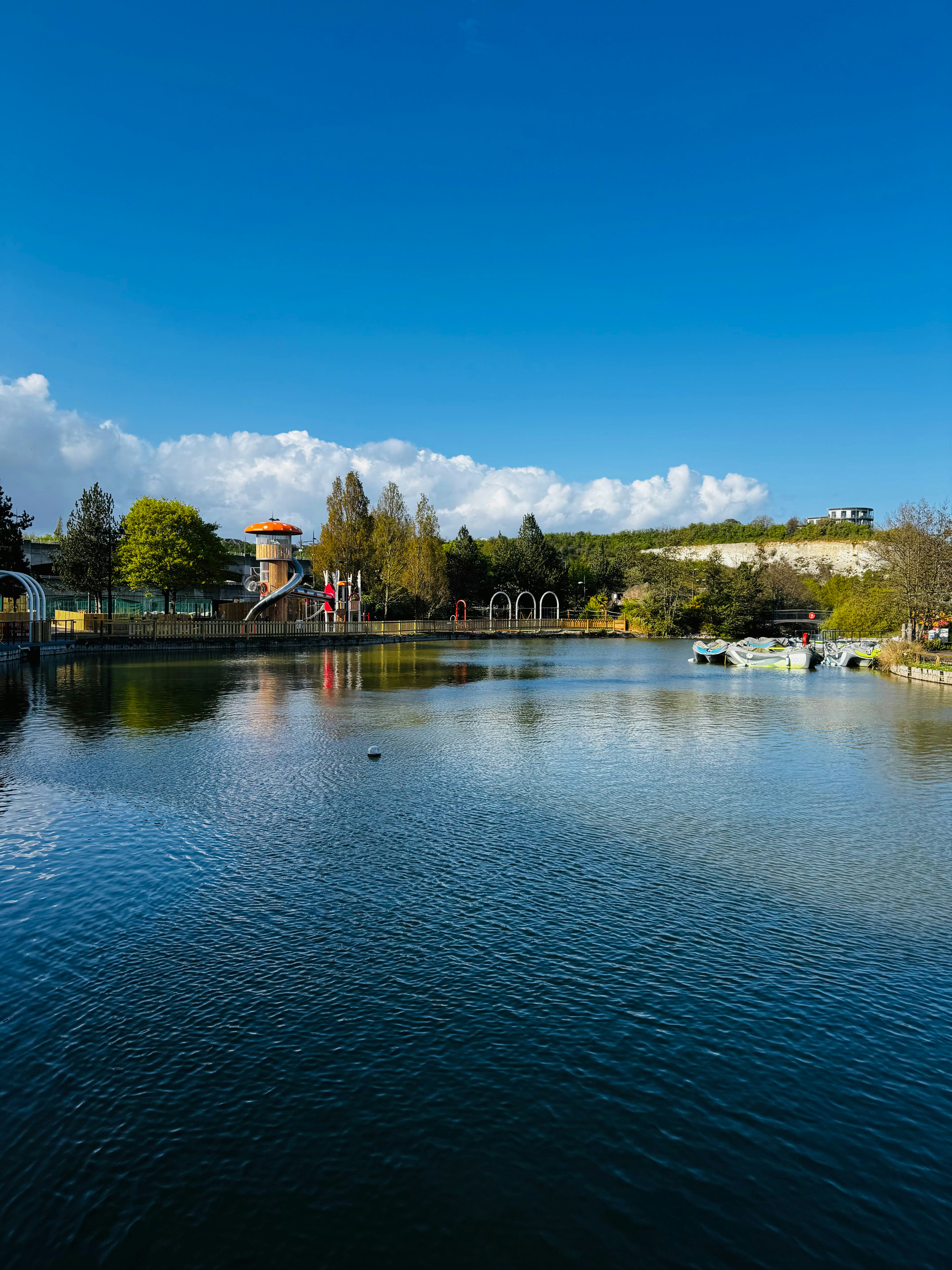 Serene lakeside playground under a crisp blue sky