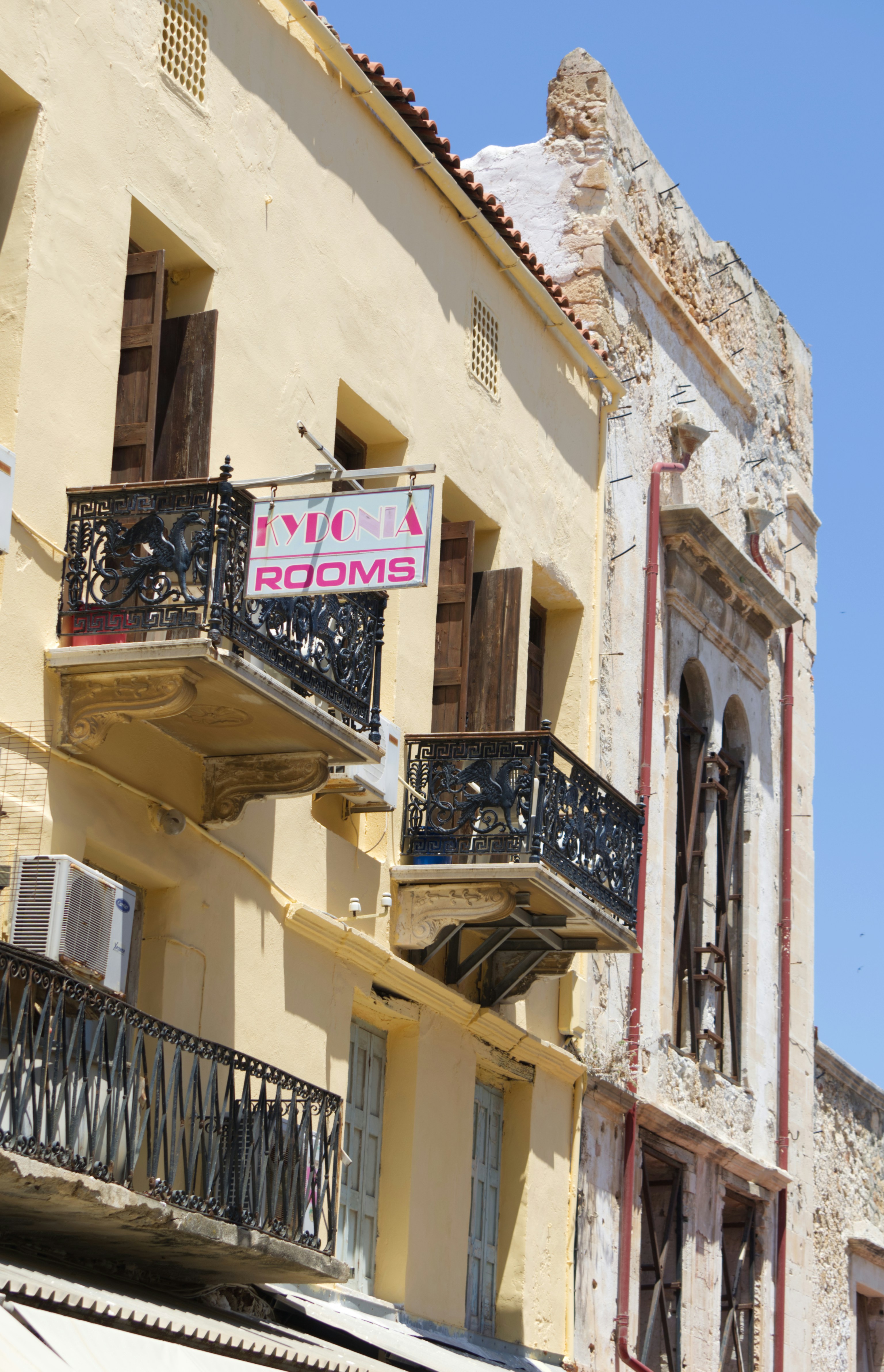 Balconies and Signage on a Sunlit Mediterranean Building