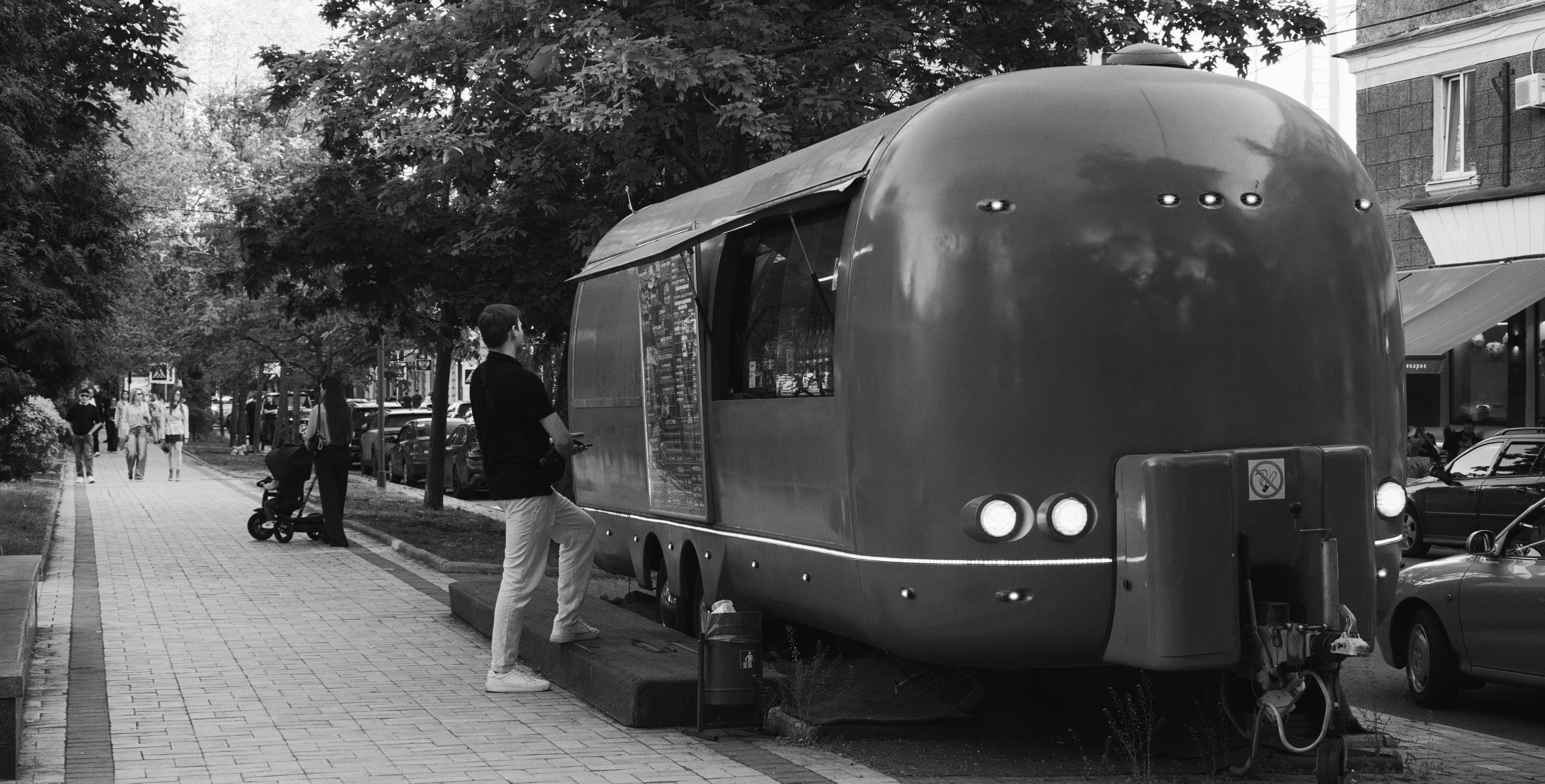 Chrome-Curtained Bus on the Pedestrian Boulevard