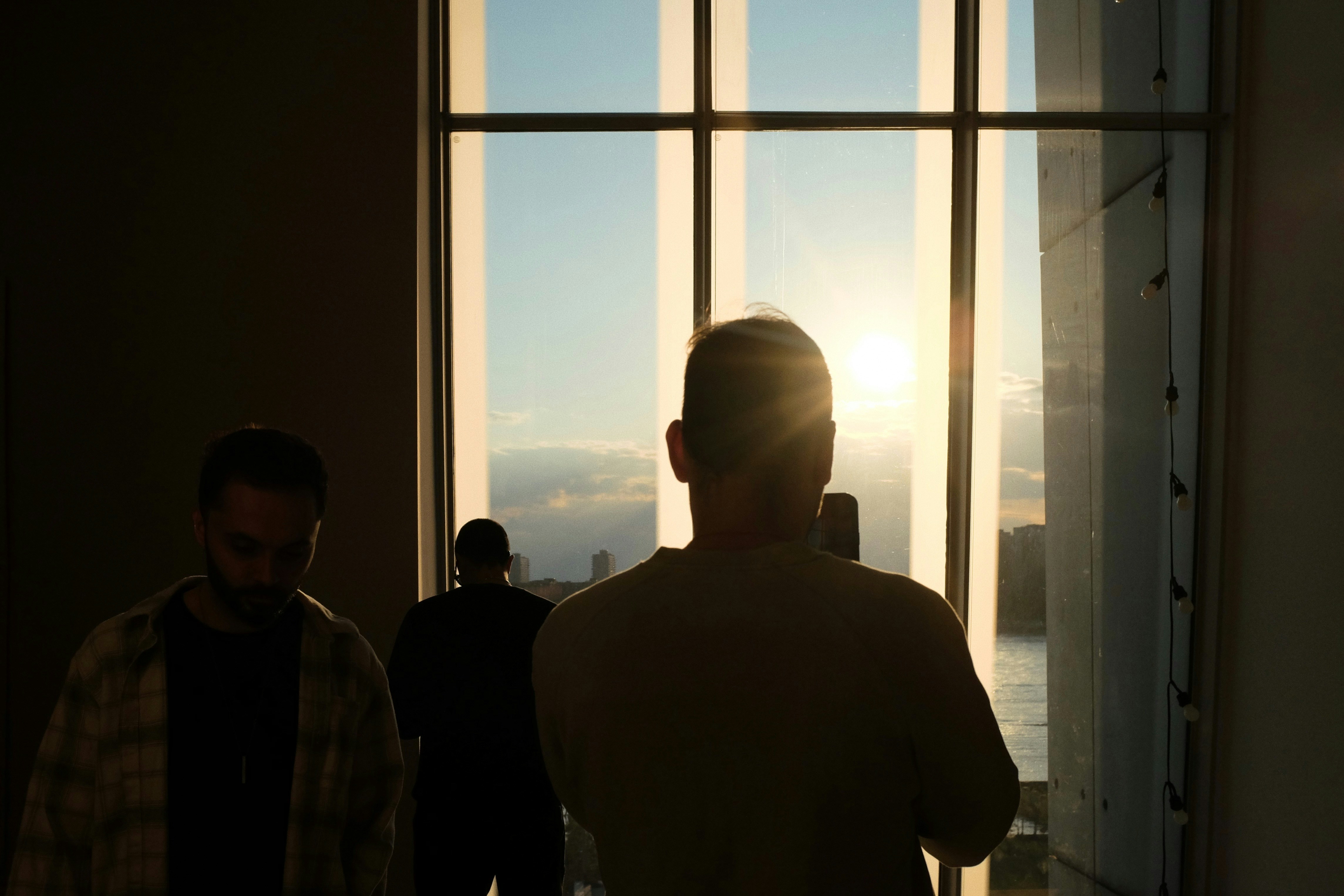 Silhouettes at the Window: Backlit Portrait in Sunlit Space