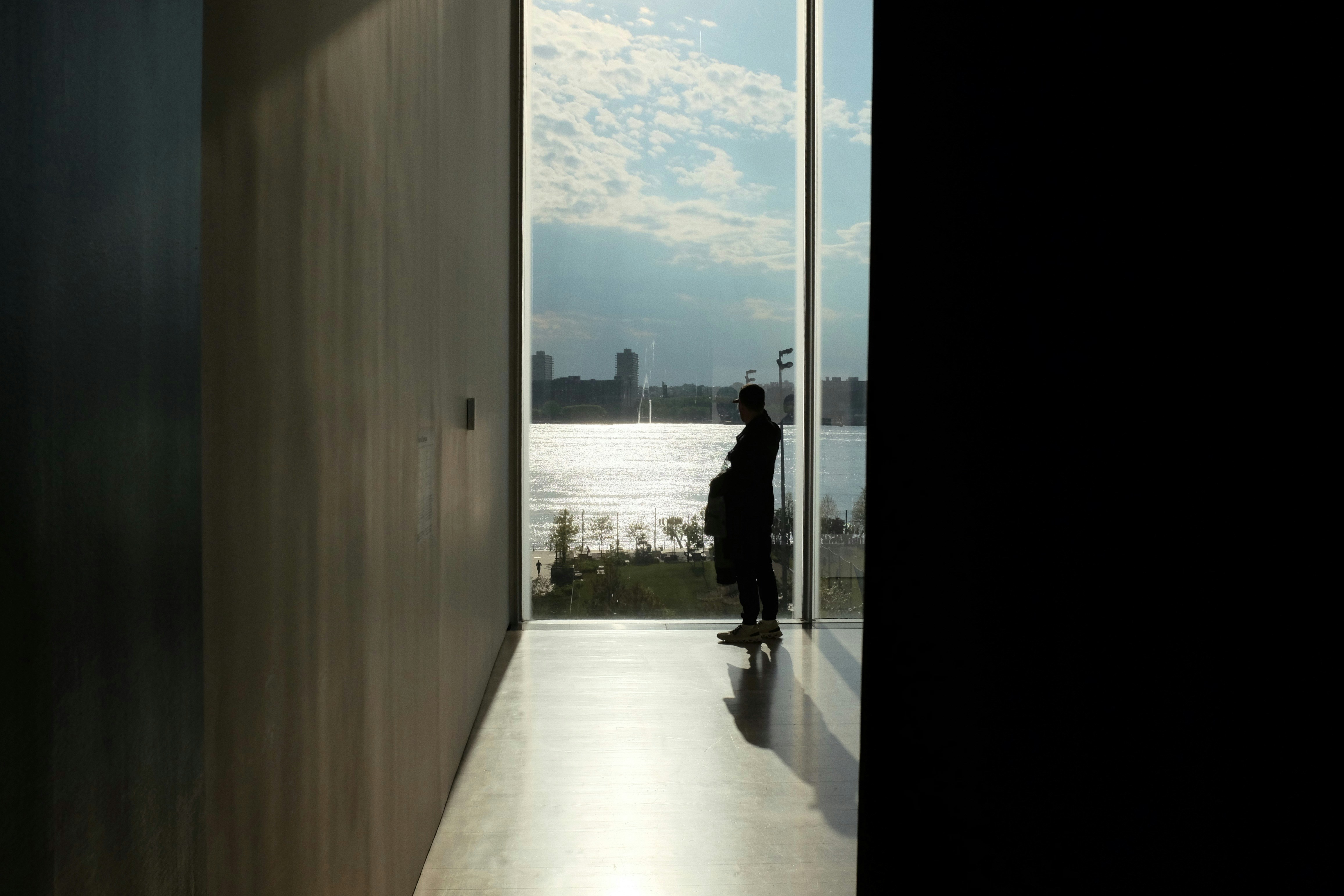 Silhouette in the Light: A Walk Toward the Waterfront