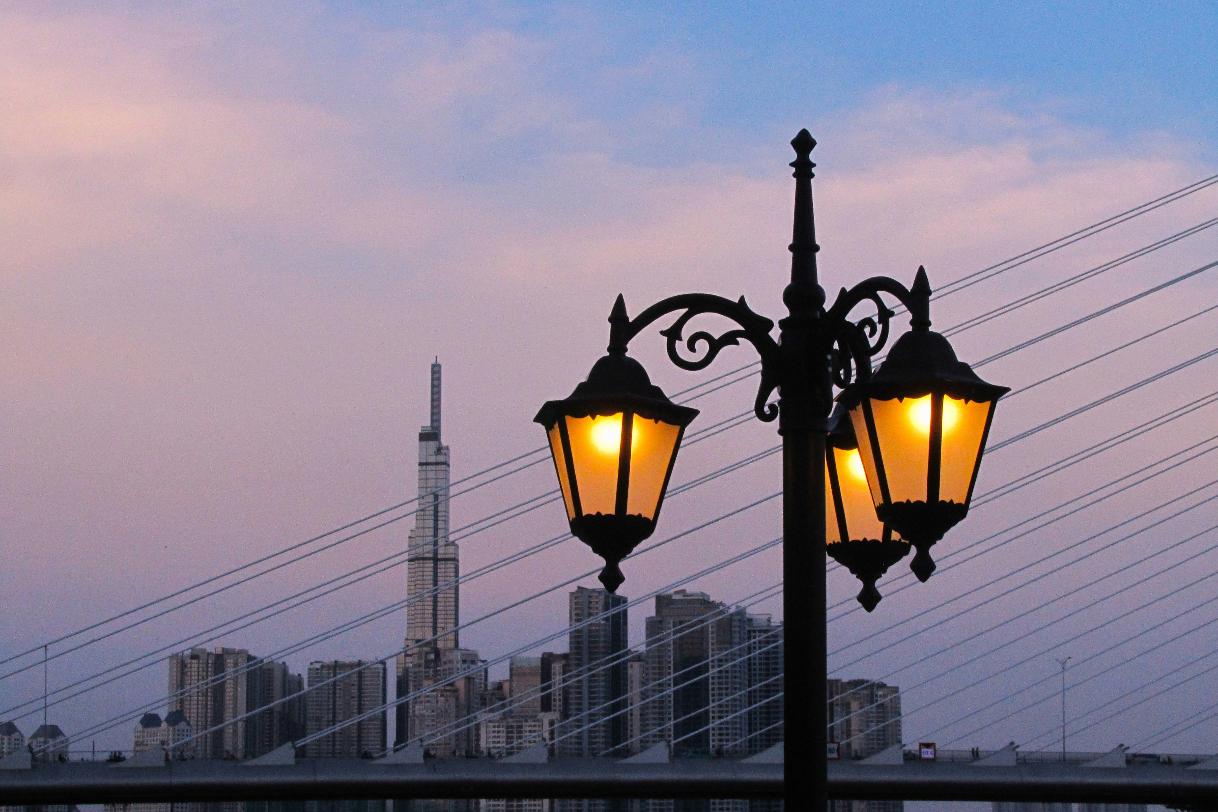 Lamplight Over Skyline: A Quiet Moment by the Rail