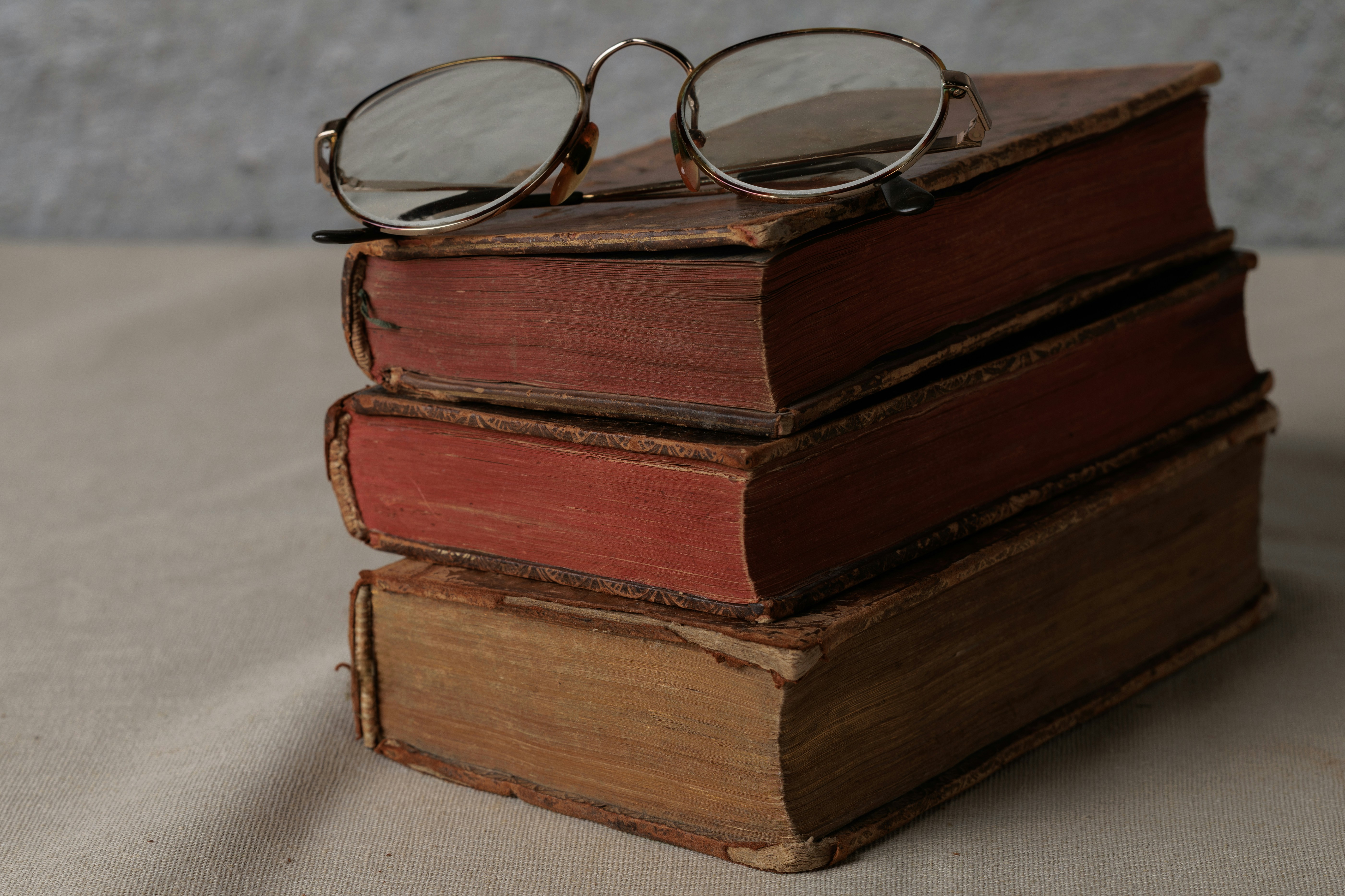 Glasses Resting on a Stacked Chronicle