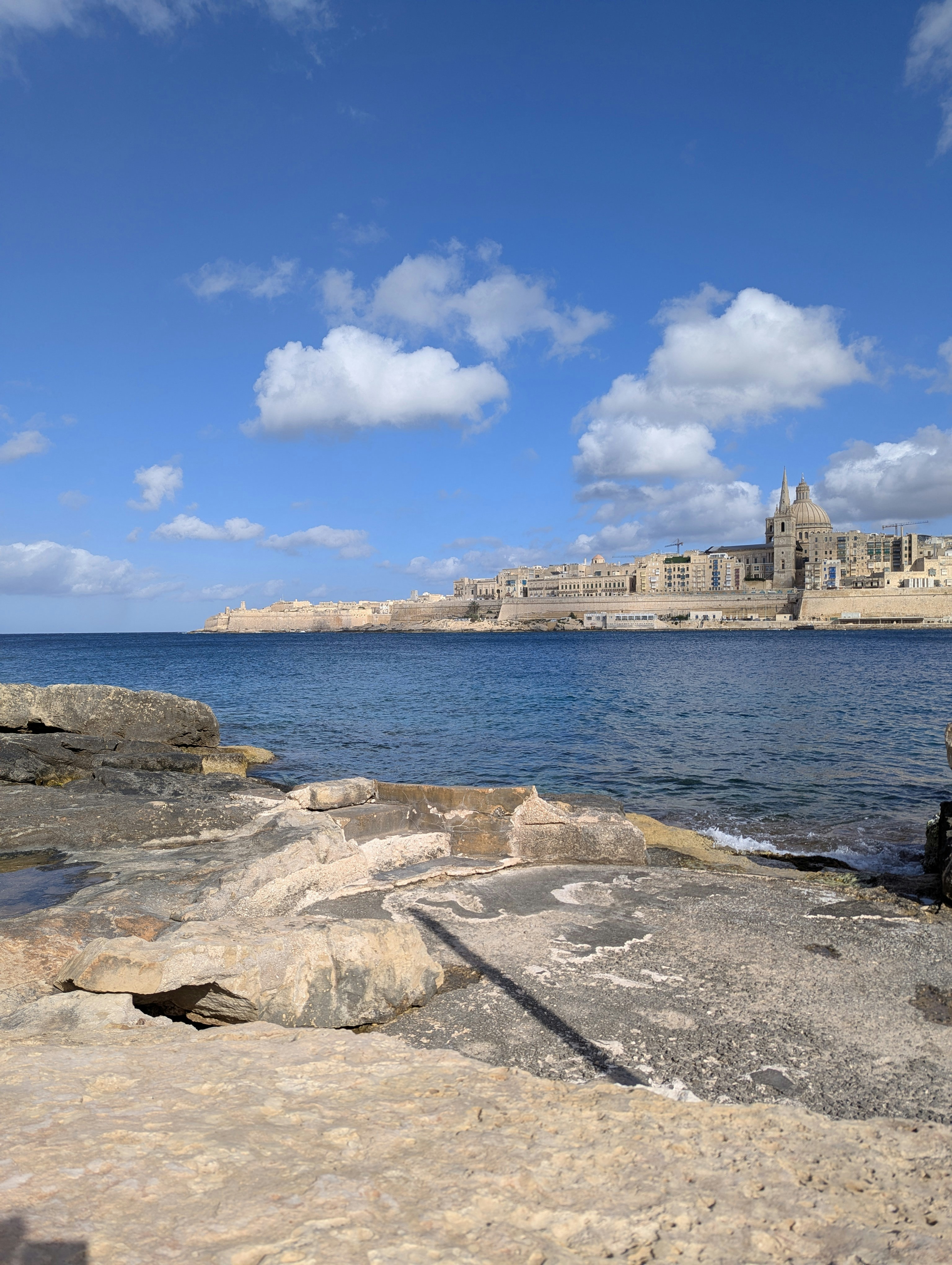 Fortress by the Sea: Stone Promenade Under a Bright Sky