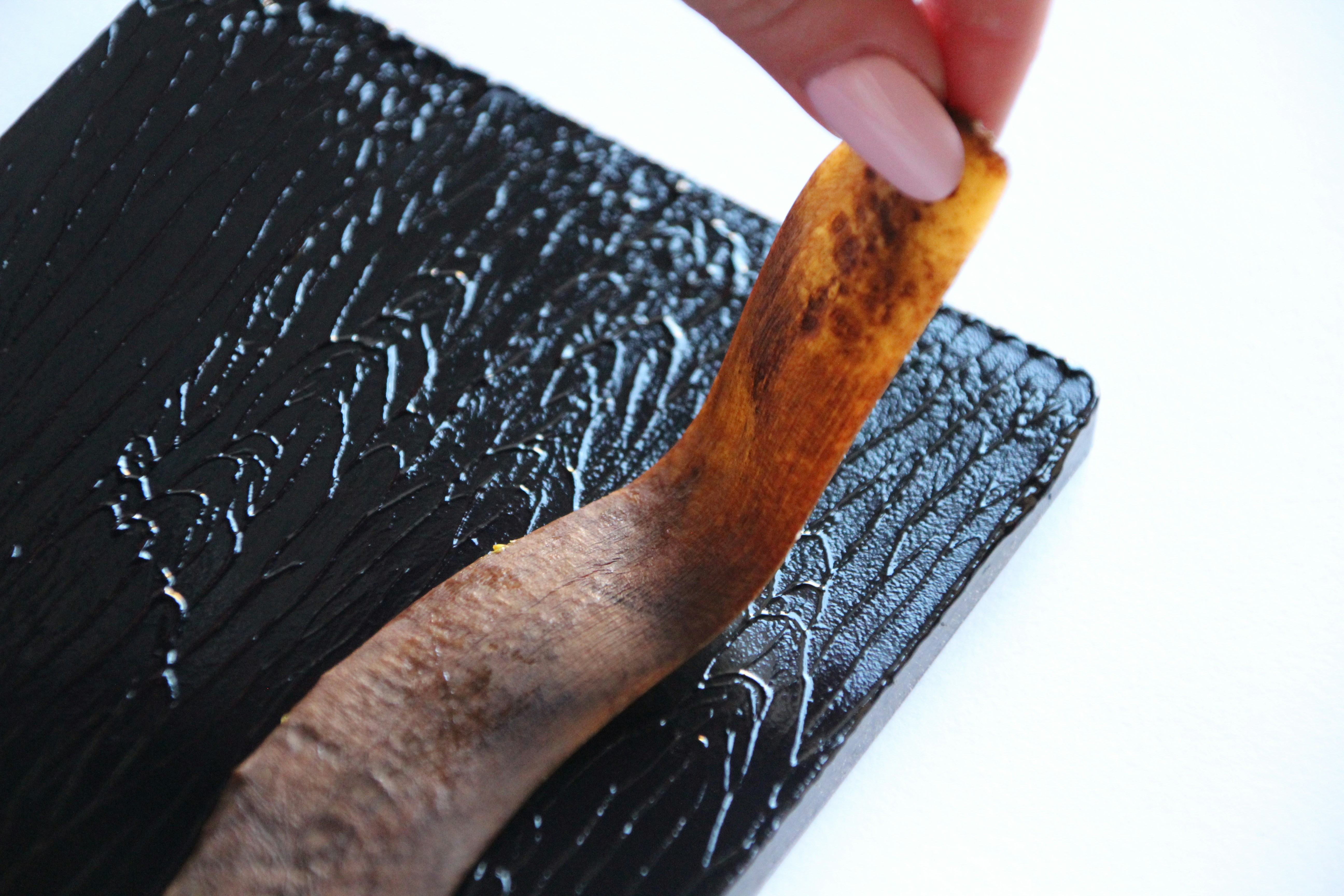 Charred Knife and Glazed Wood: A Macro Moment