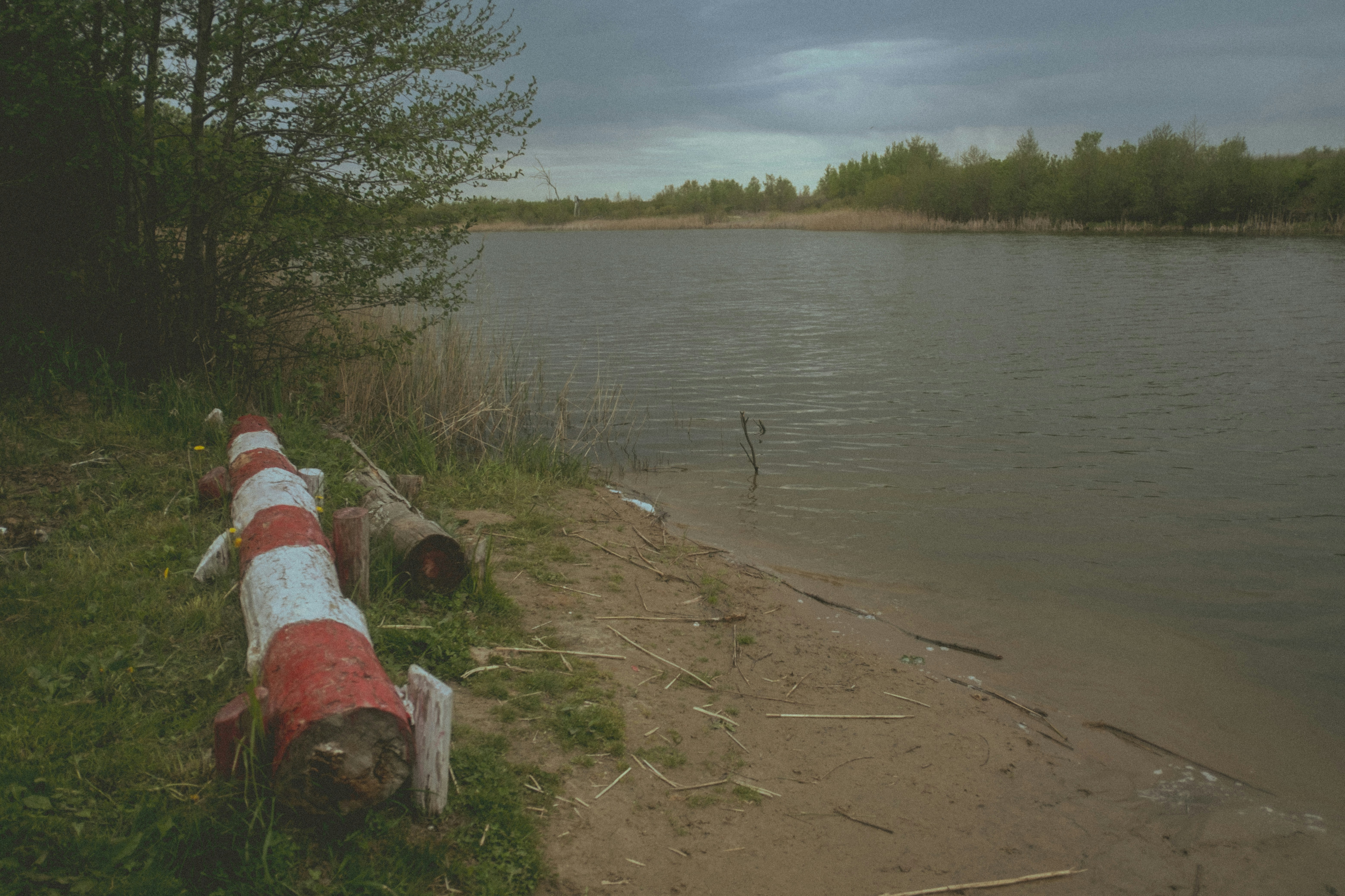 Rusted beacons ride the shoreline’s edge