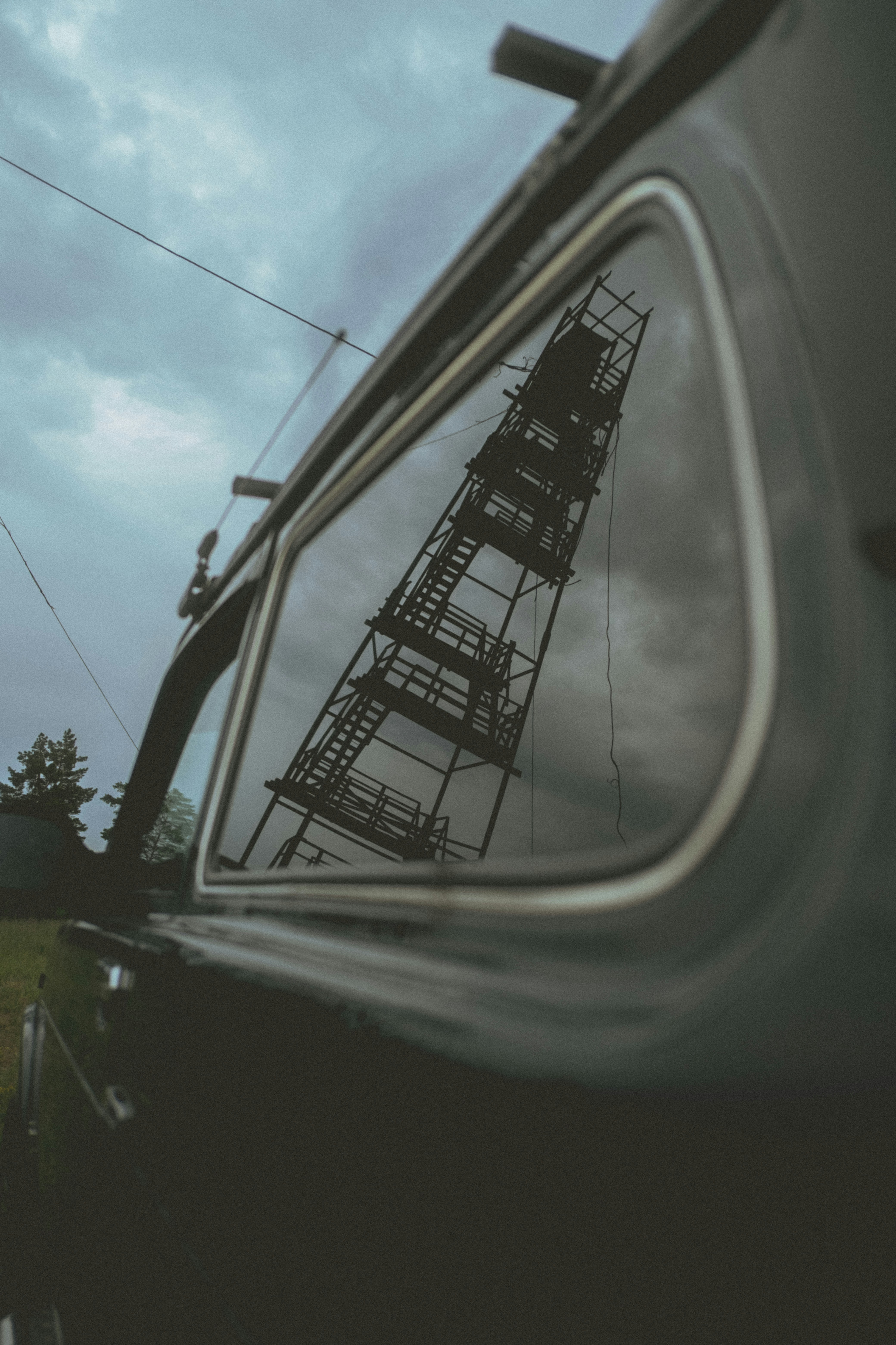 Reflection in the Side Window: Tower Silhouette on a Shiny Car
