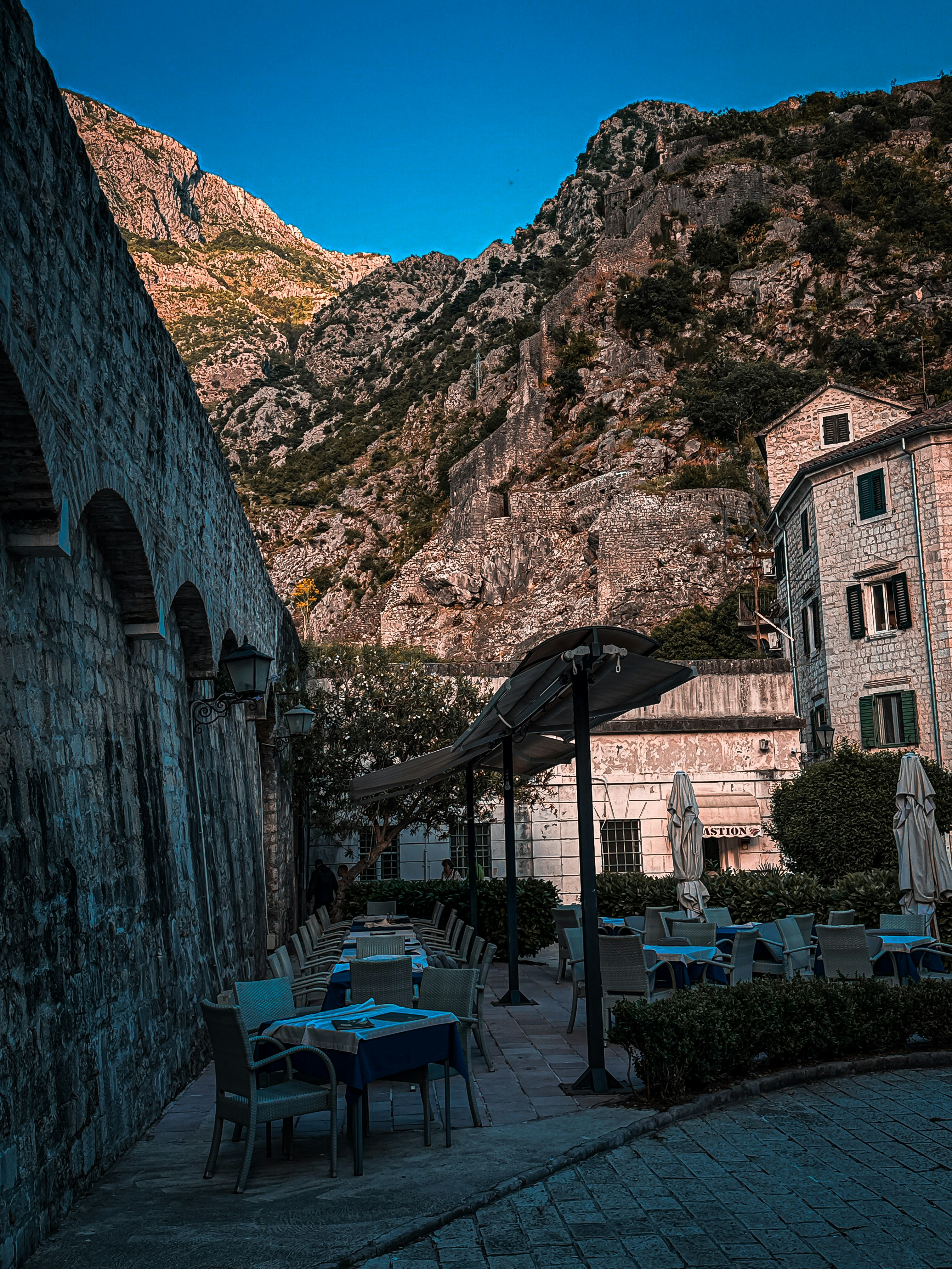 Stone Courtyard Beneath a Fierce Mountain