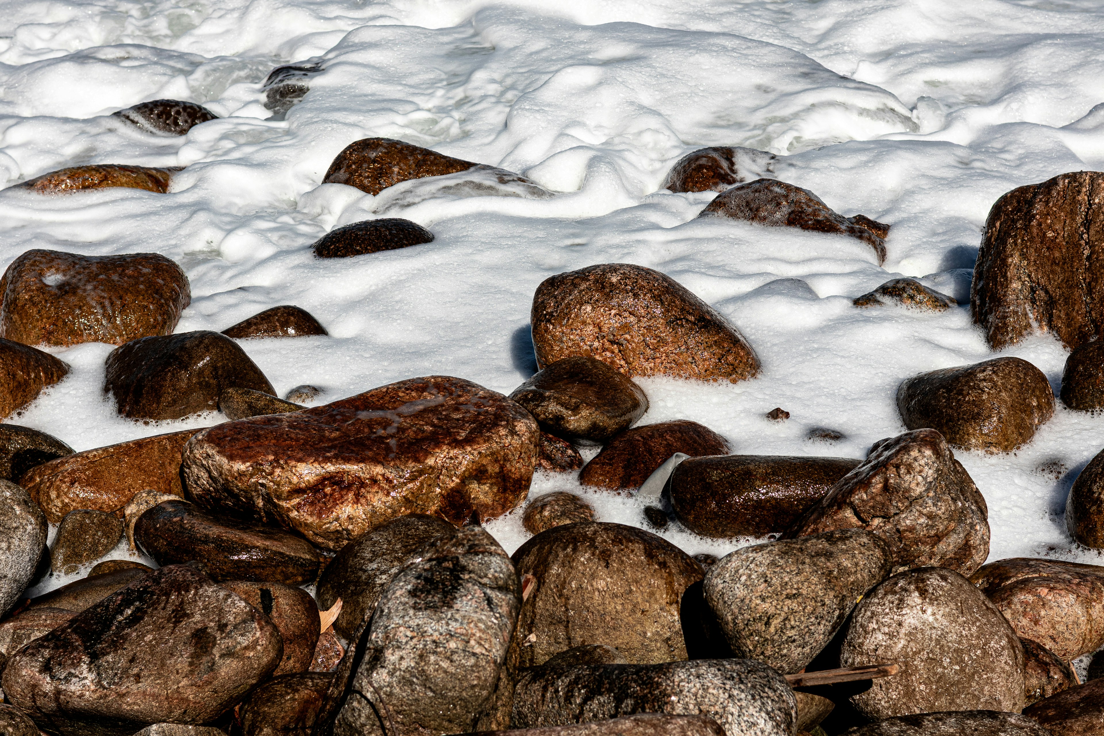 Snow-Capped Stones: A Quiet Sea of Pebbles in Winter Light