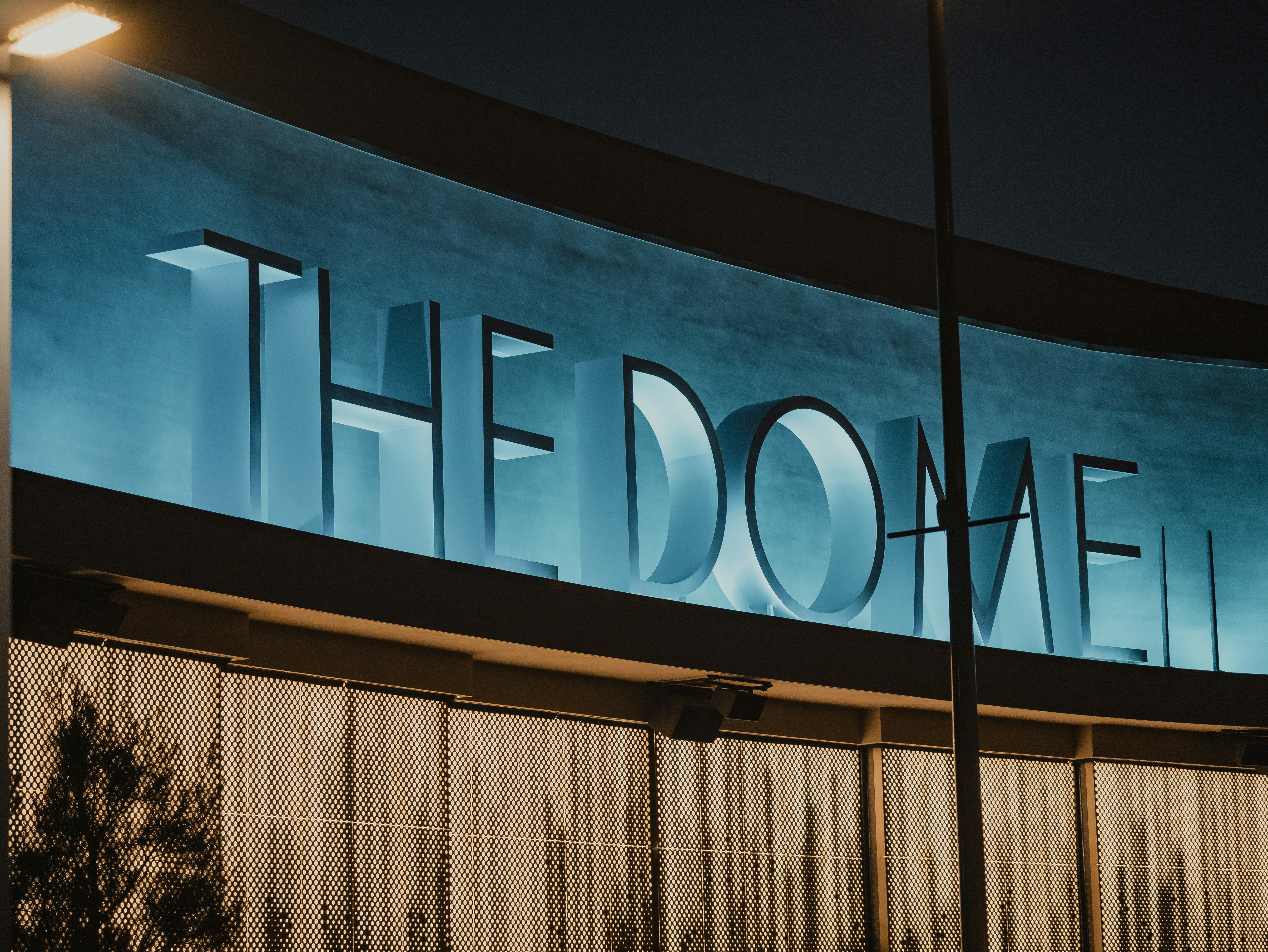 Neon Curve: The Dome Signlit Under Streetlamp