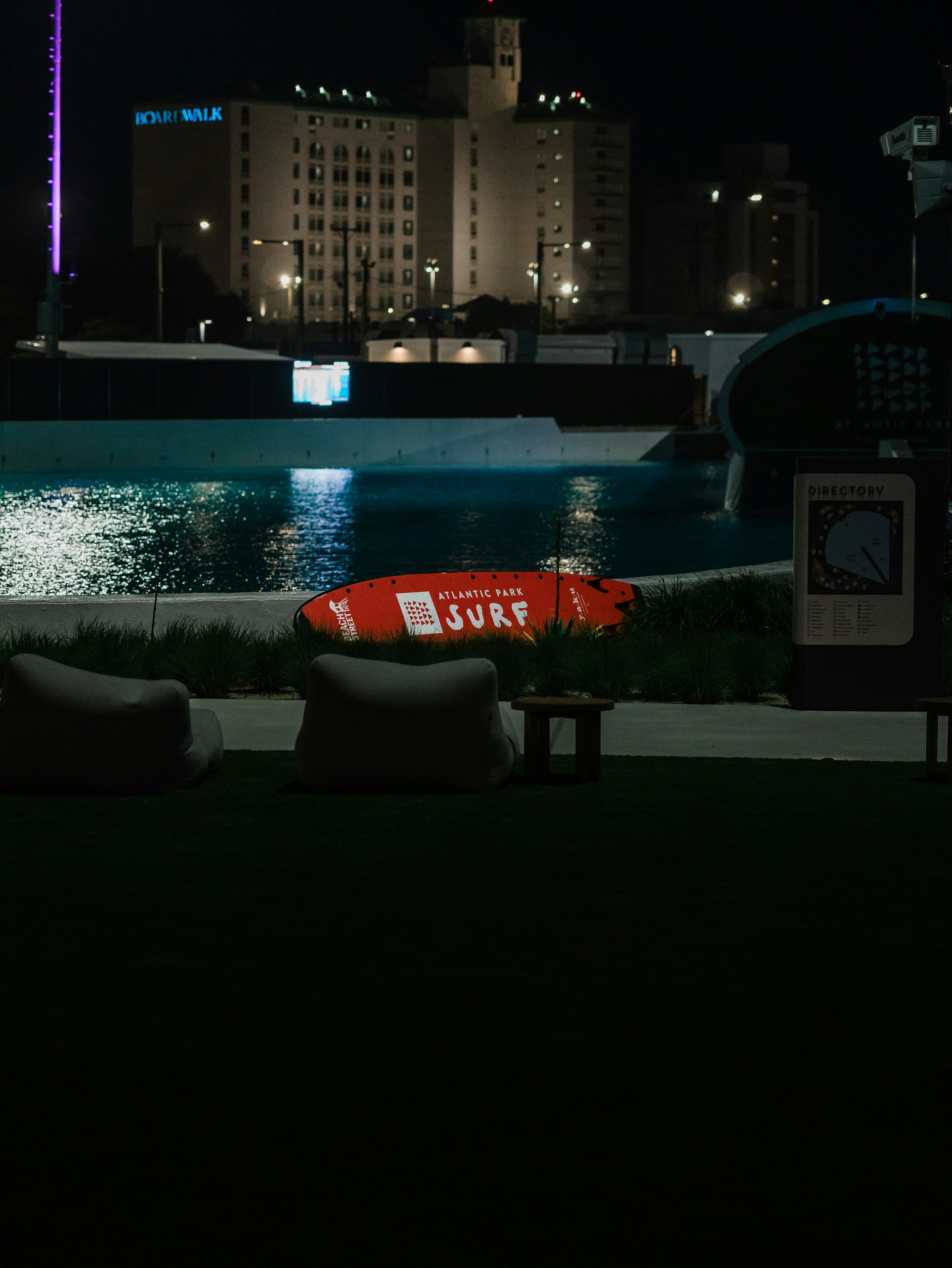 Red Surfboard by the Night Pool
