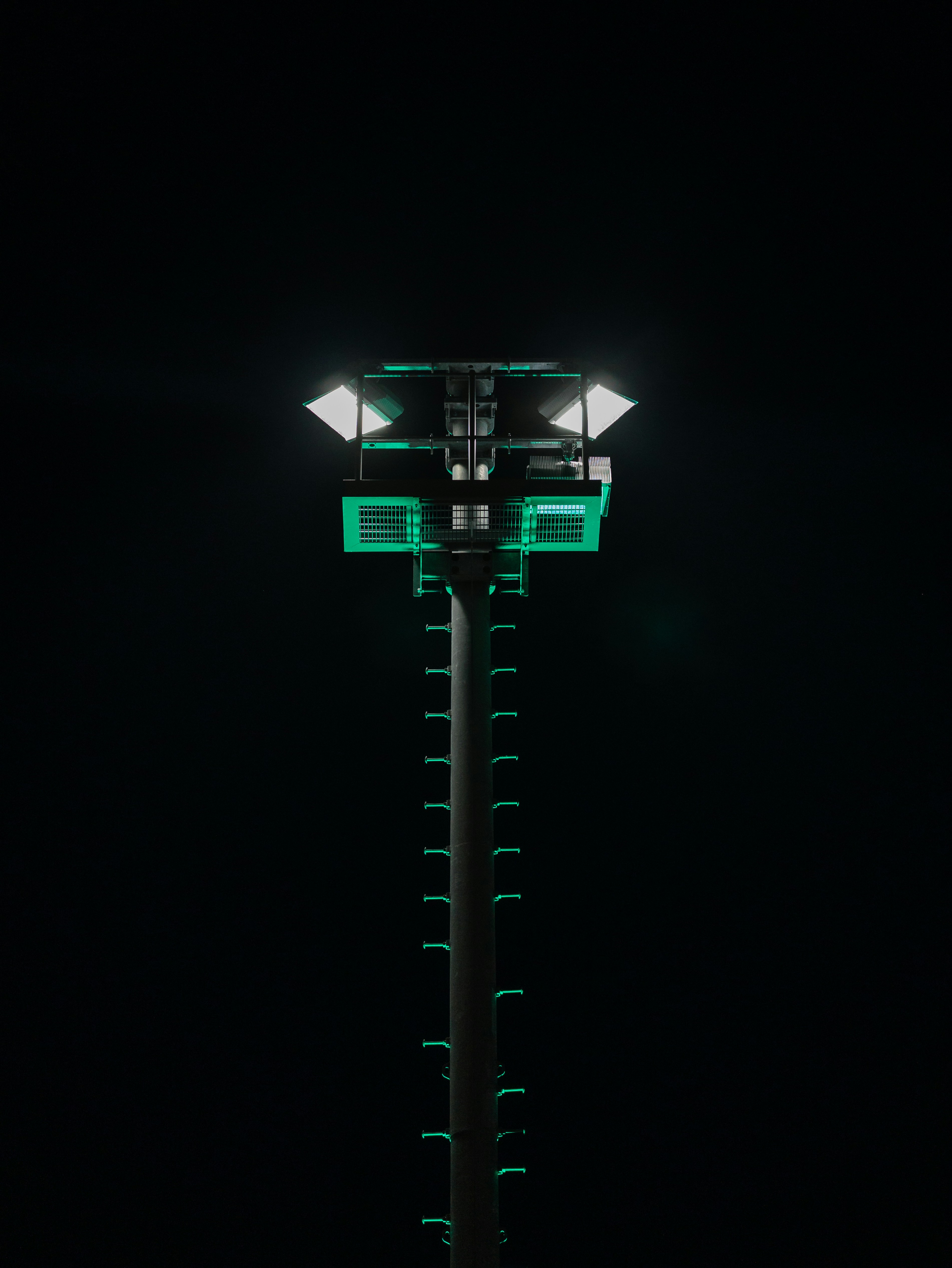 Night Beacon: A Lone Stadium Tower Reaching for the Sky