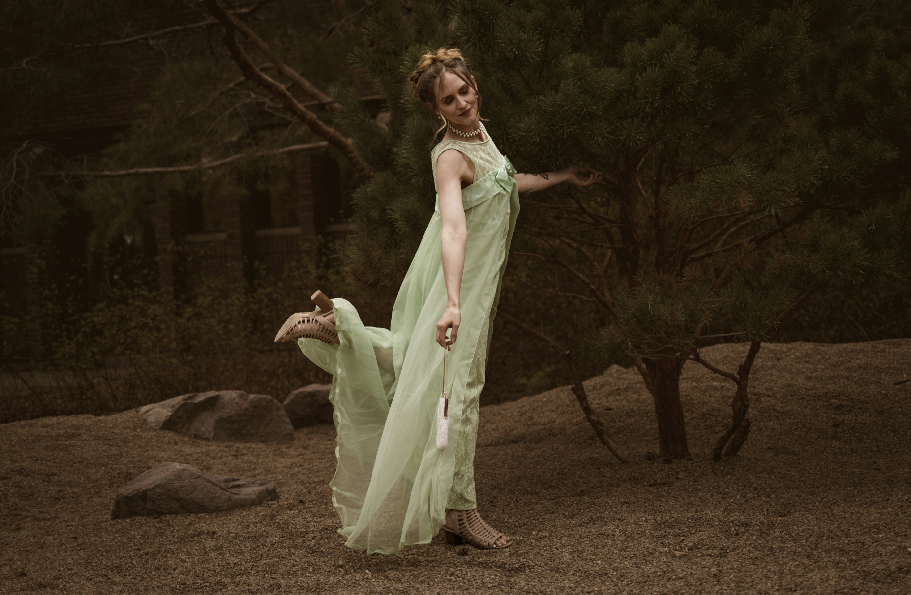 Green-gowned dancer in a quiet woodland clearing