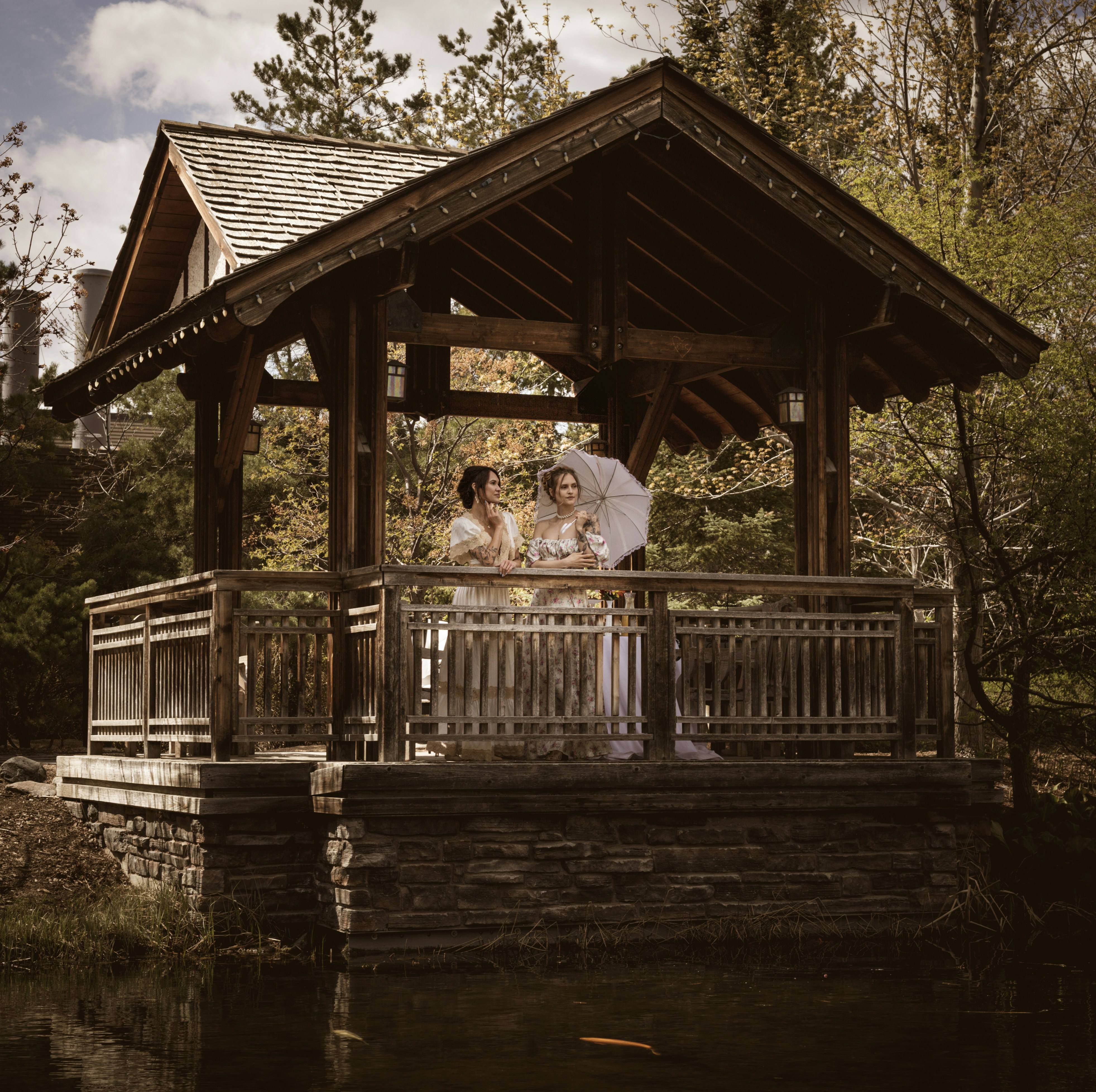 Elegance on the Water: A Gentle Moment Under the Timbered Pavilion