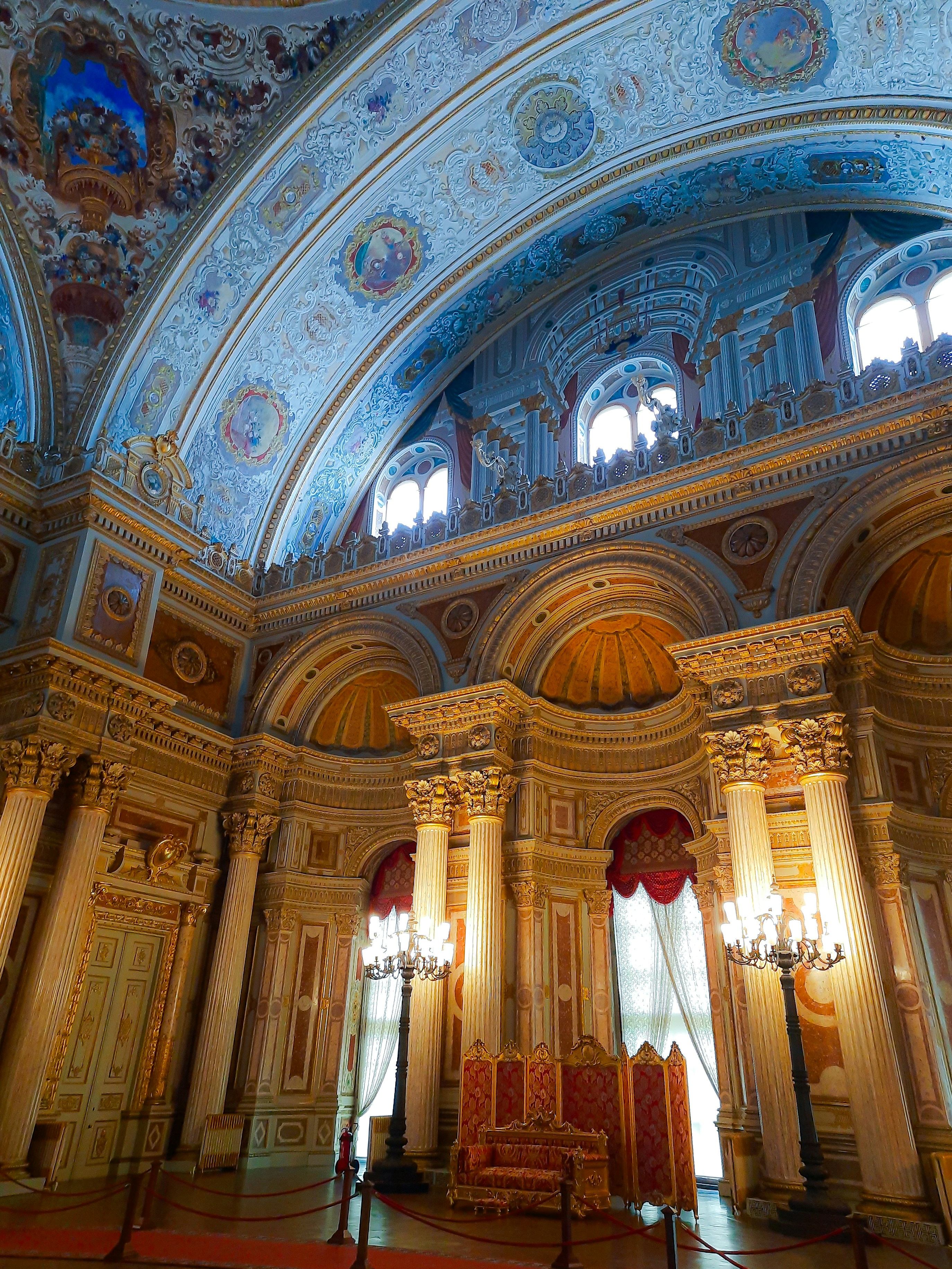 Ornate Cathedral Hall: Light, Columns, and Velvet Throne