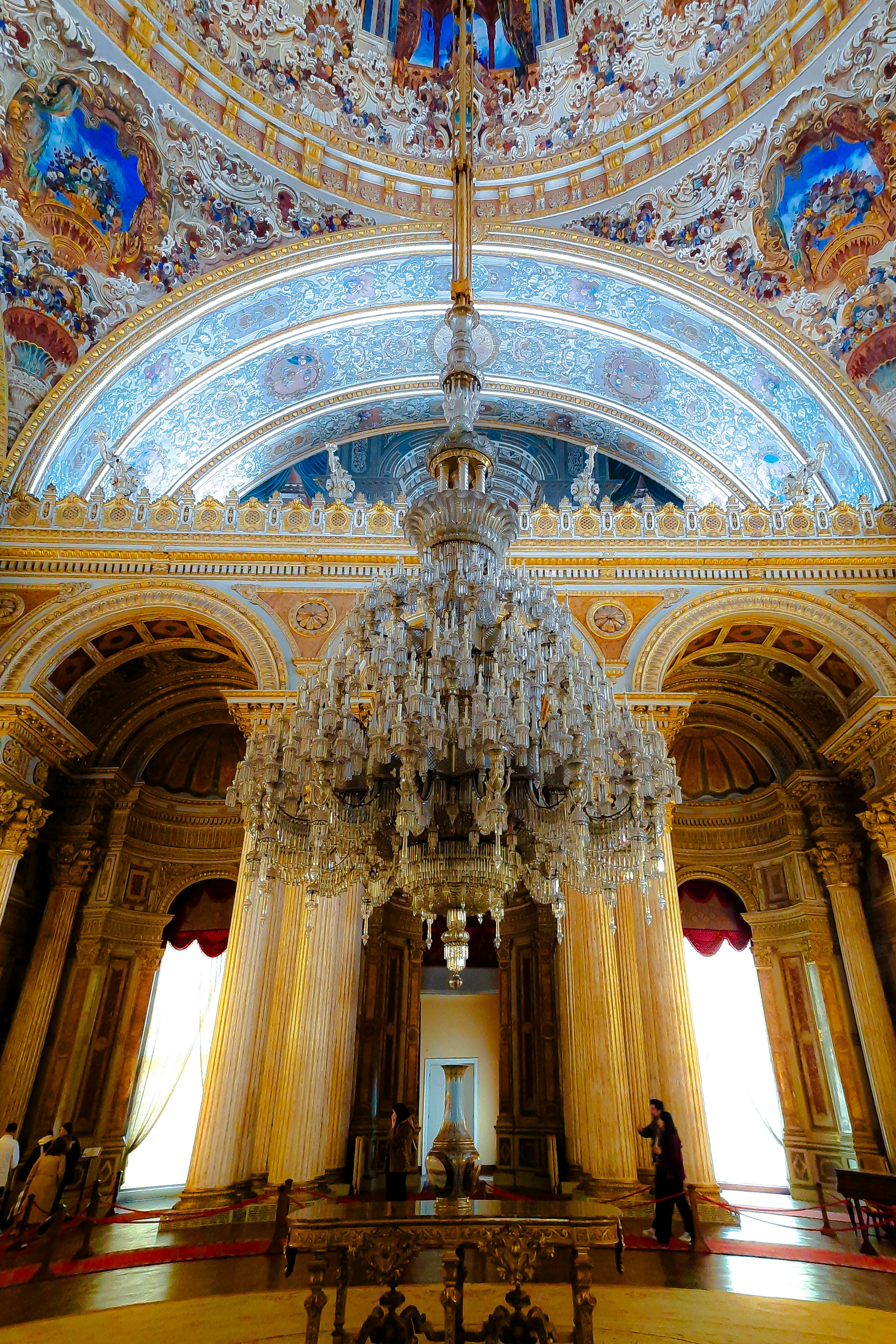 Crystal Crown of a Grand Hall: A Lavish Chandelier Against Ornate Ceilings