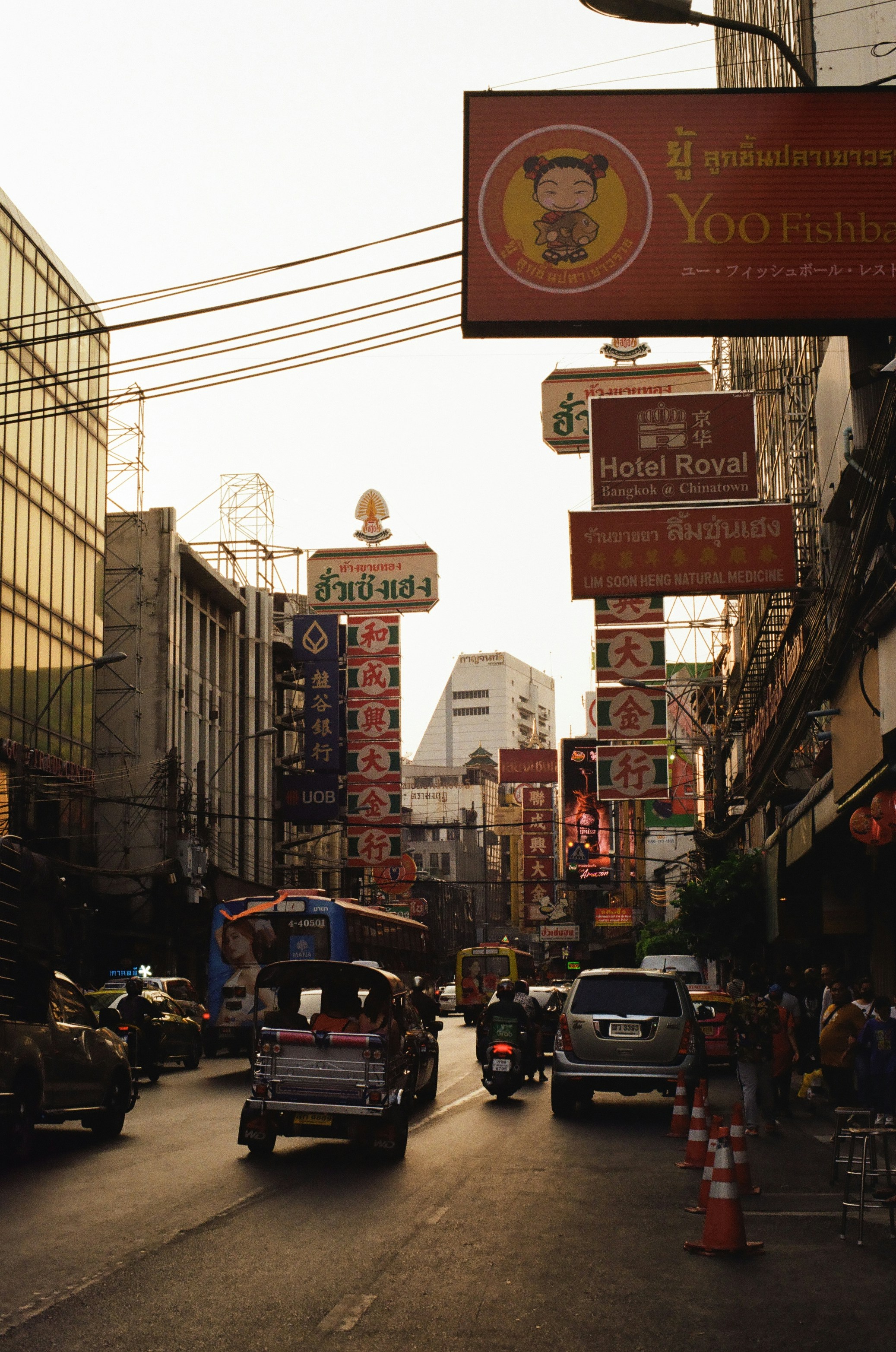 Neon Confetti Street: Signs and Traffic Pour Through a Bustling Chinatown Corridor
