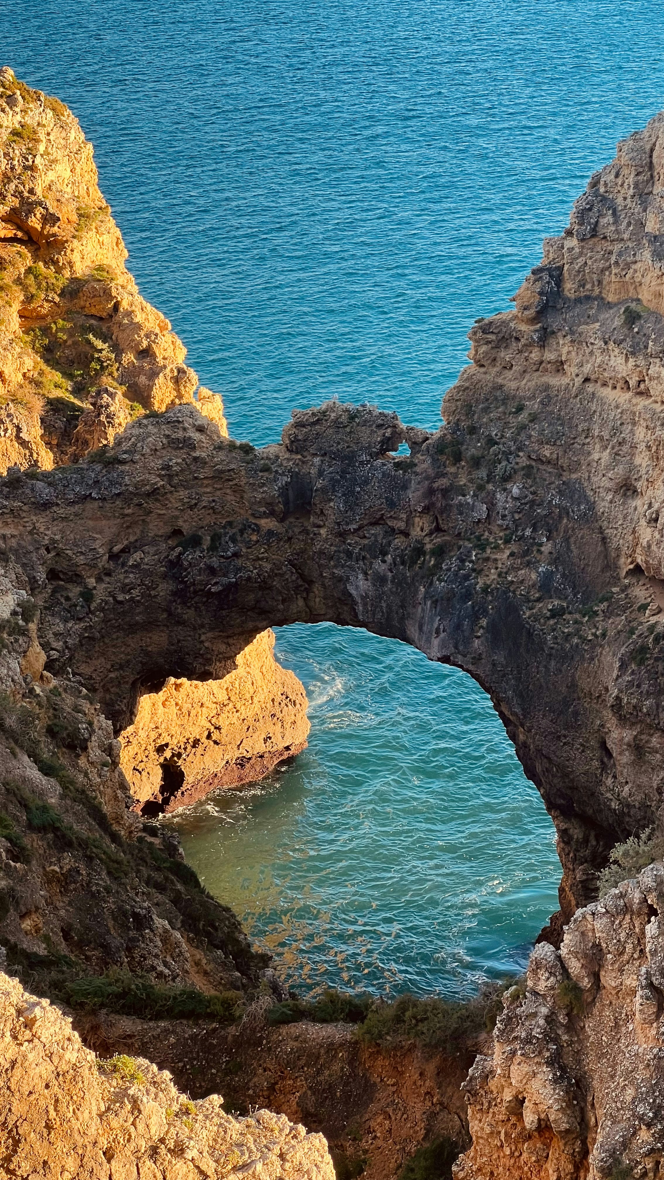 Natural Stone Arch Framing a Turquoise Cove