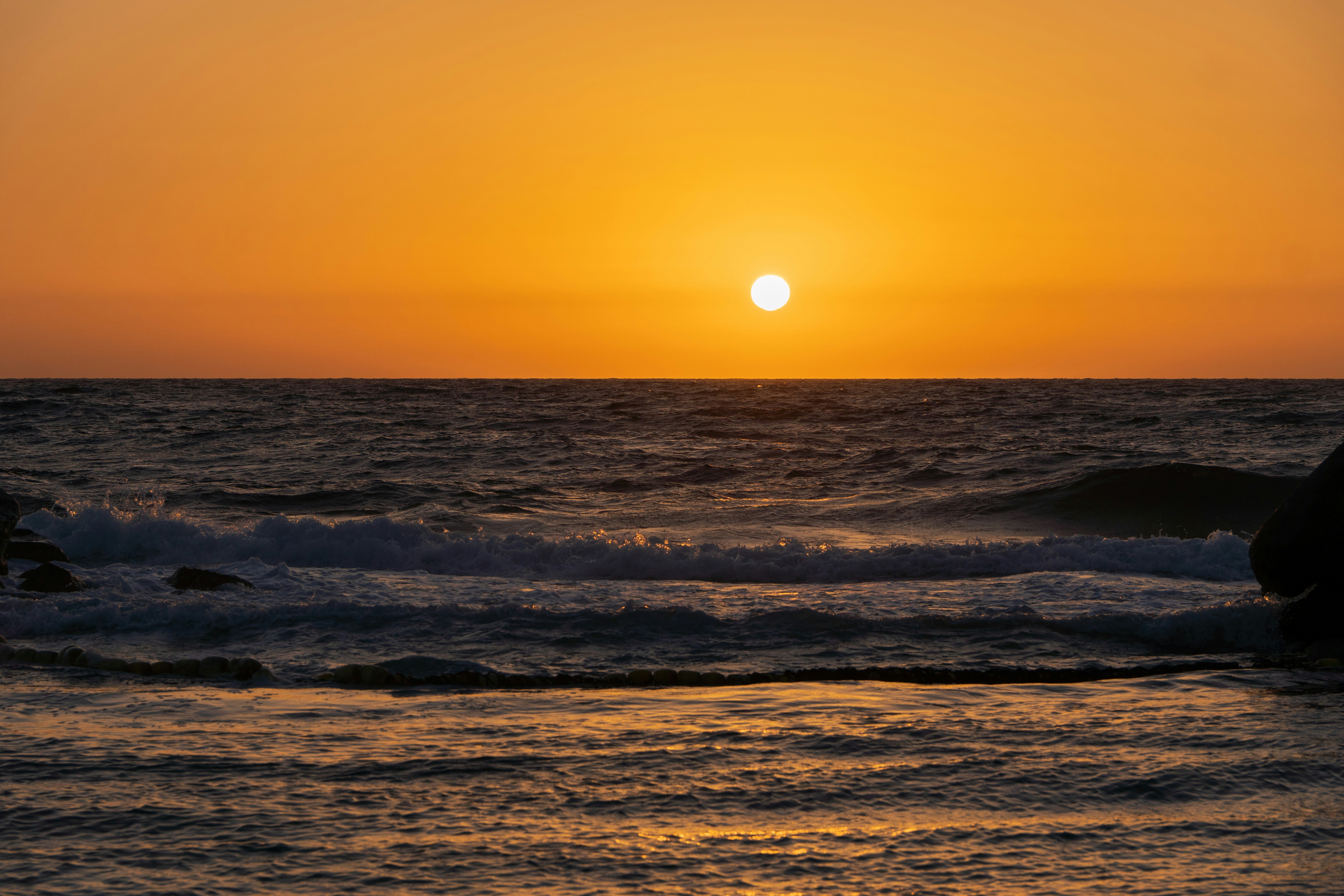 Solitary Sun at the Horizon: Quiet Sea in Evening Gold