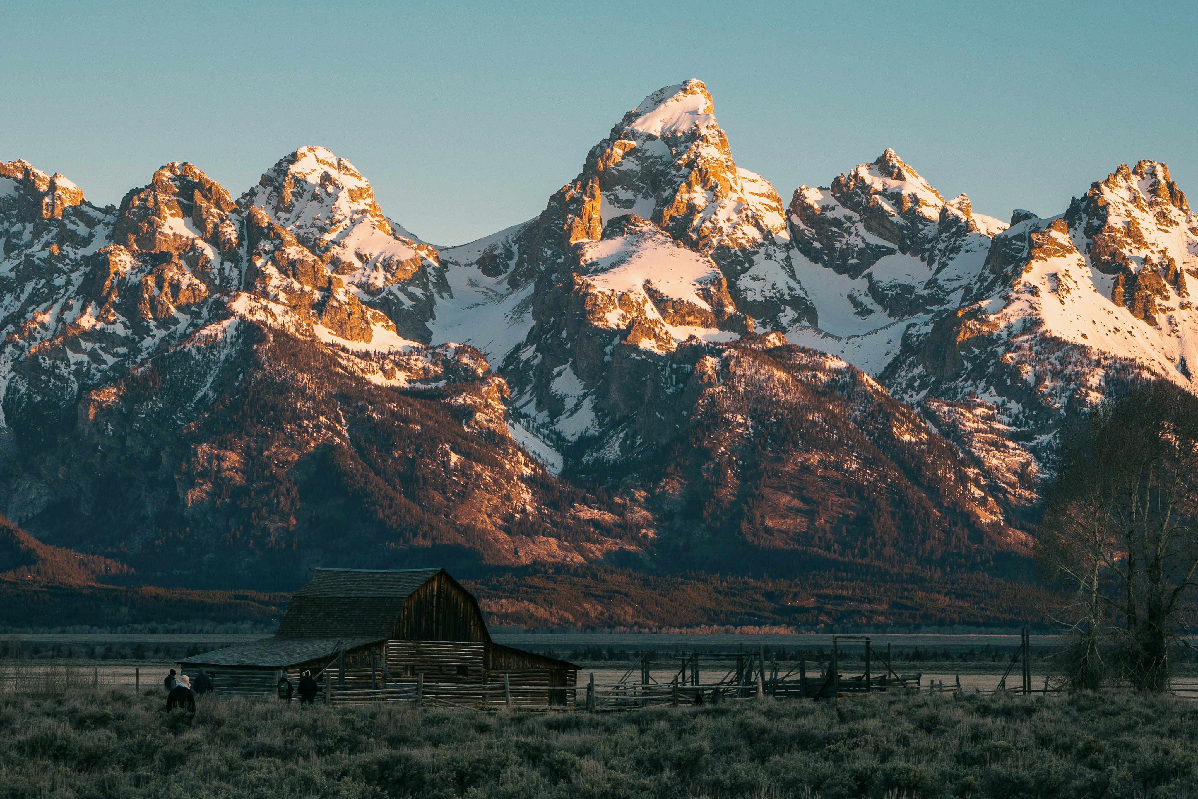Sunlit Peaks Over a Rustic Farmyard