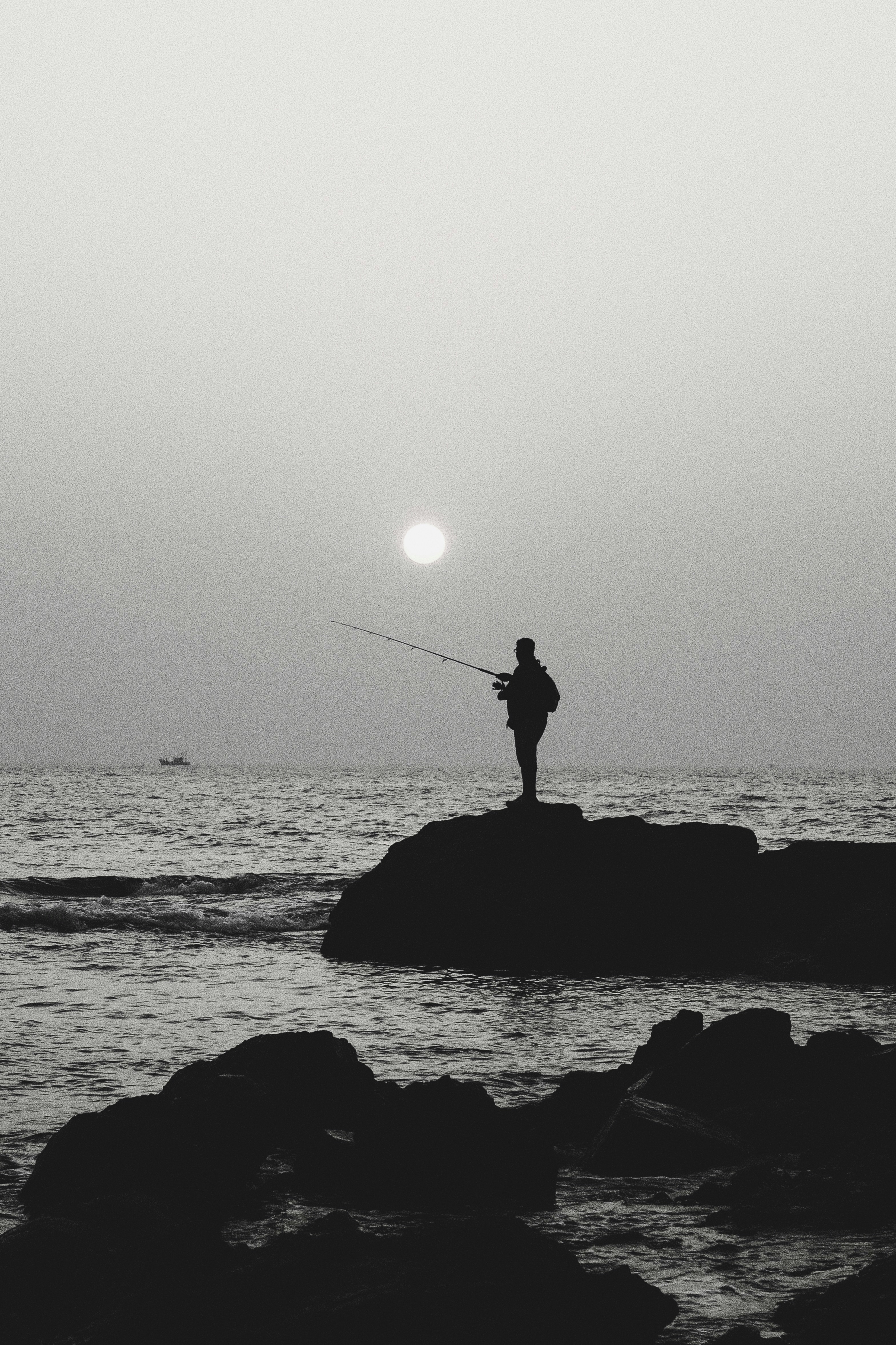 Solitary Angler at the Horizon: A Quiet Silhouette Above the Sea