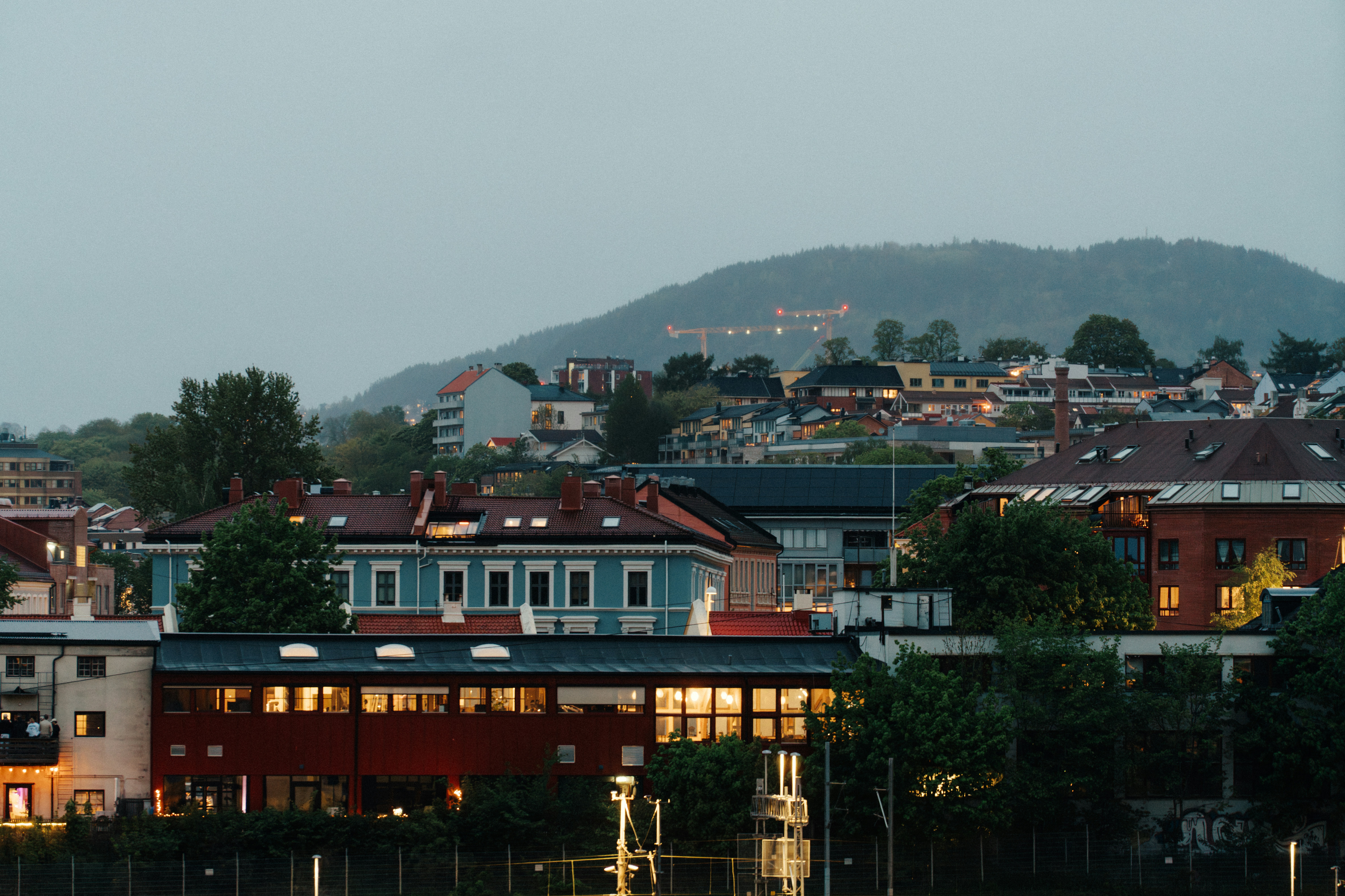 Distant Hills Over a Quiet Urban Roofscape at Dusk