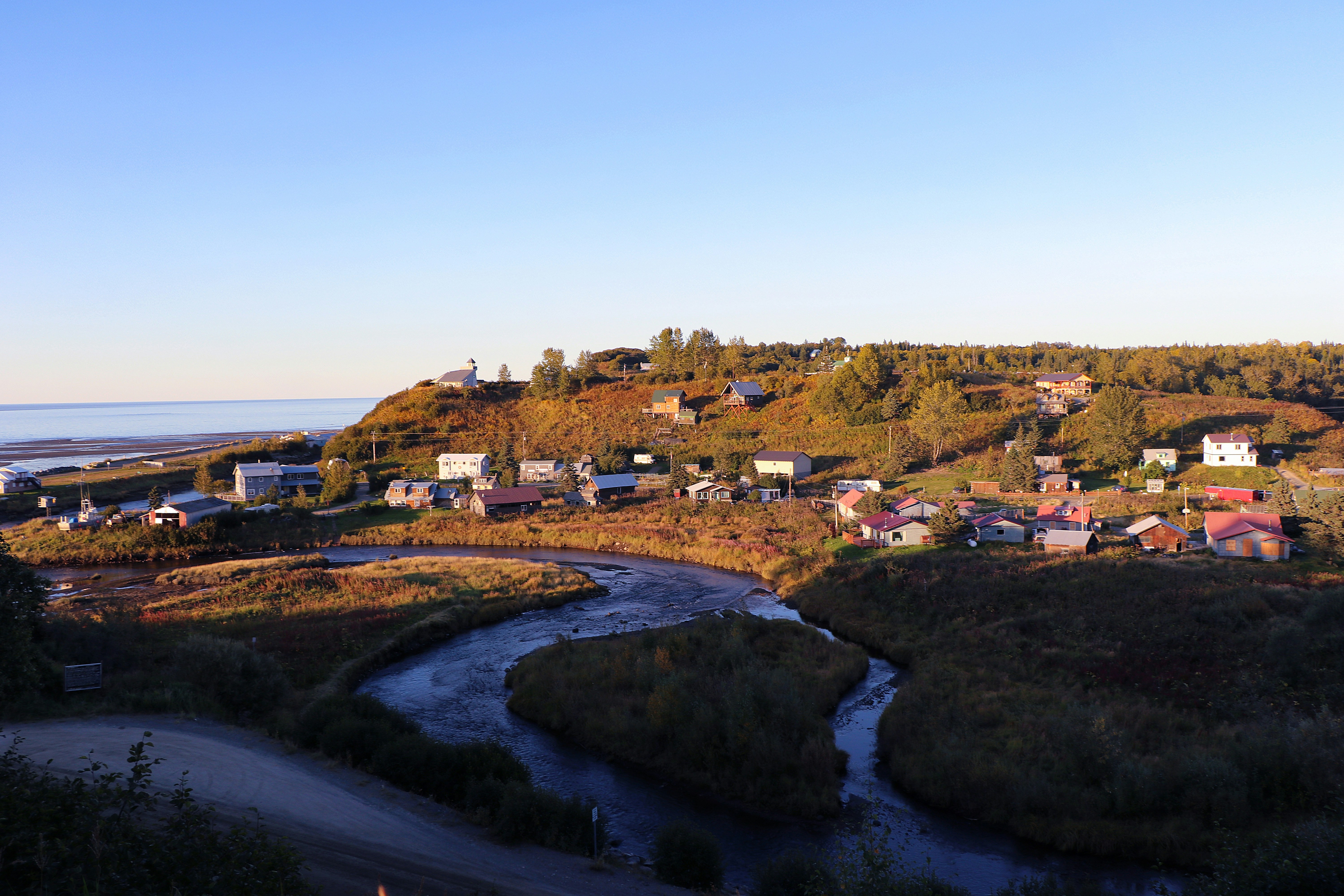 Coastal Village at Dusk: A Quiet River Bend Embraces the Sea