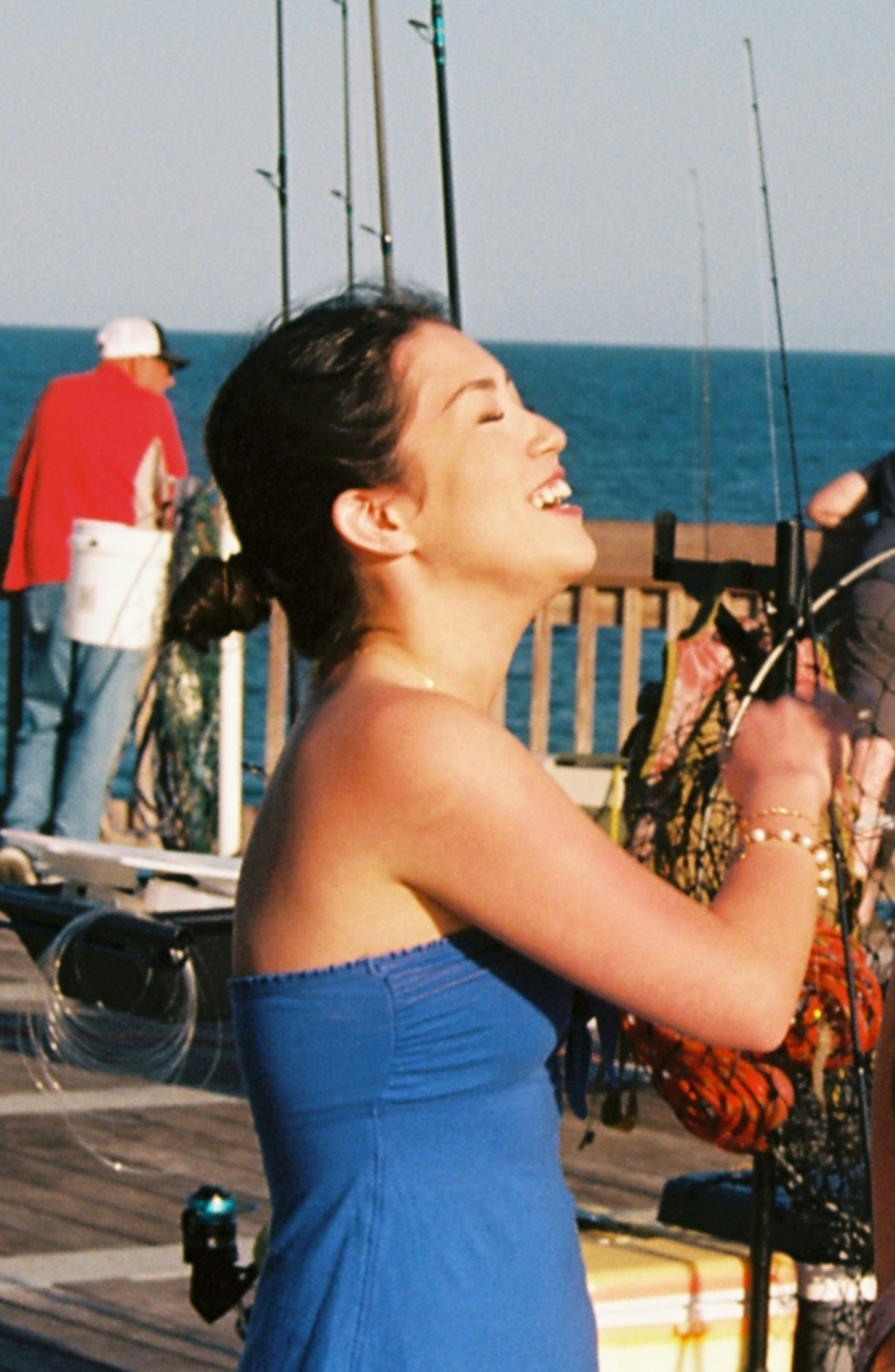 Sunlit Smile on the Pier: A Moment of Joy by the Sea