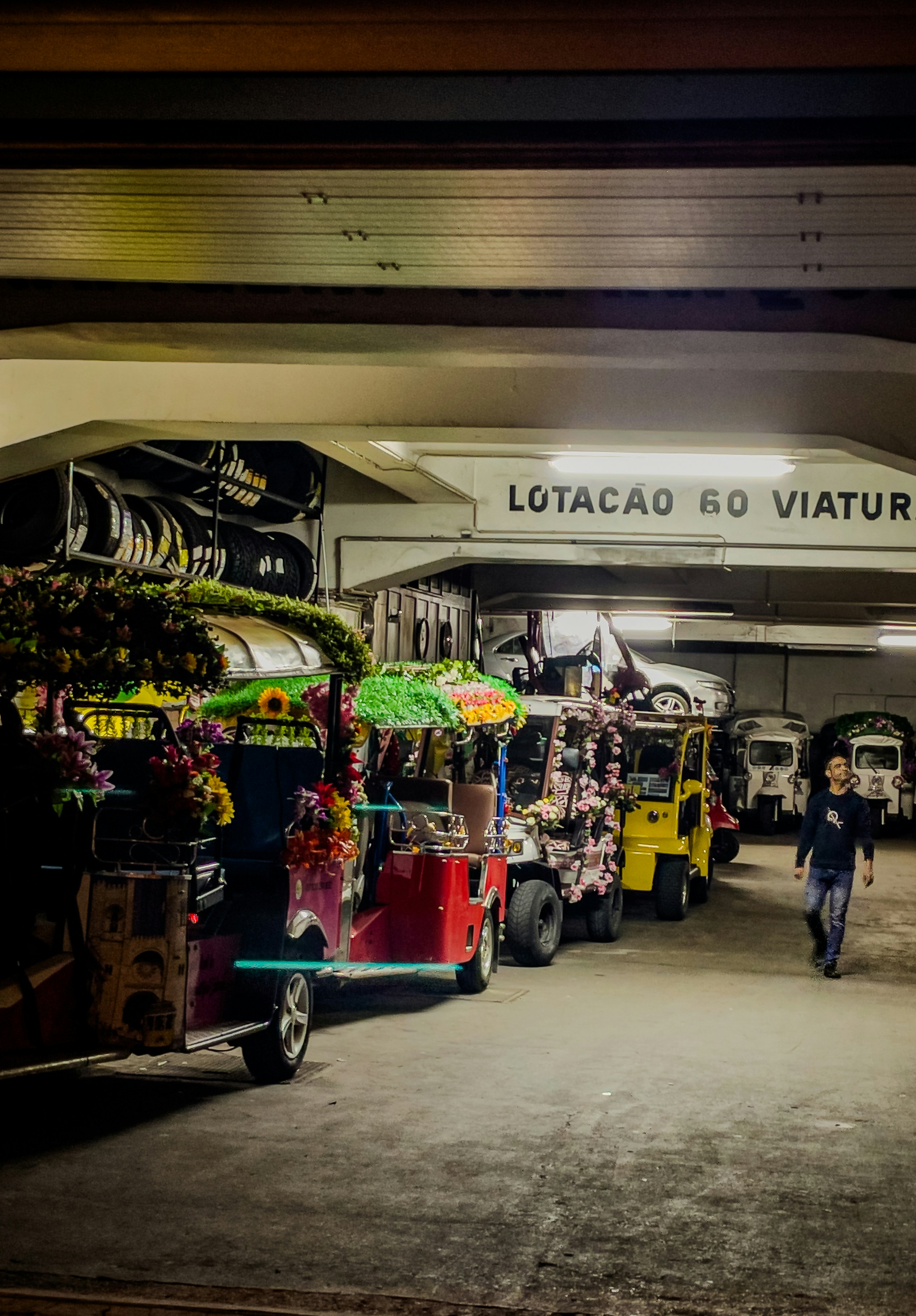 Flowered Cart Parade Under a City Parking Entrance