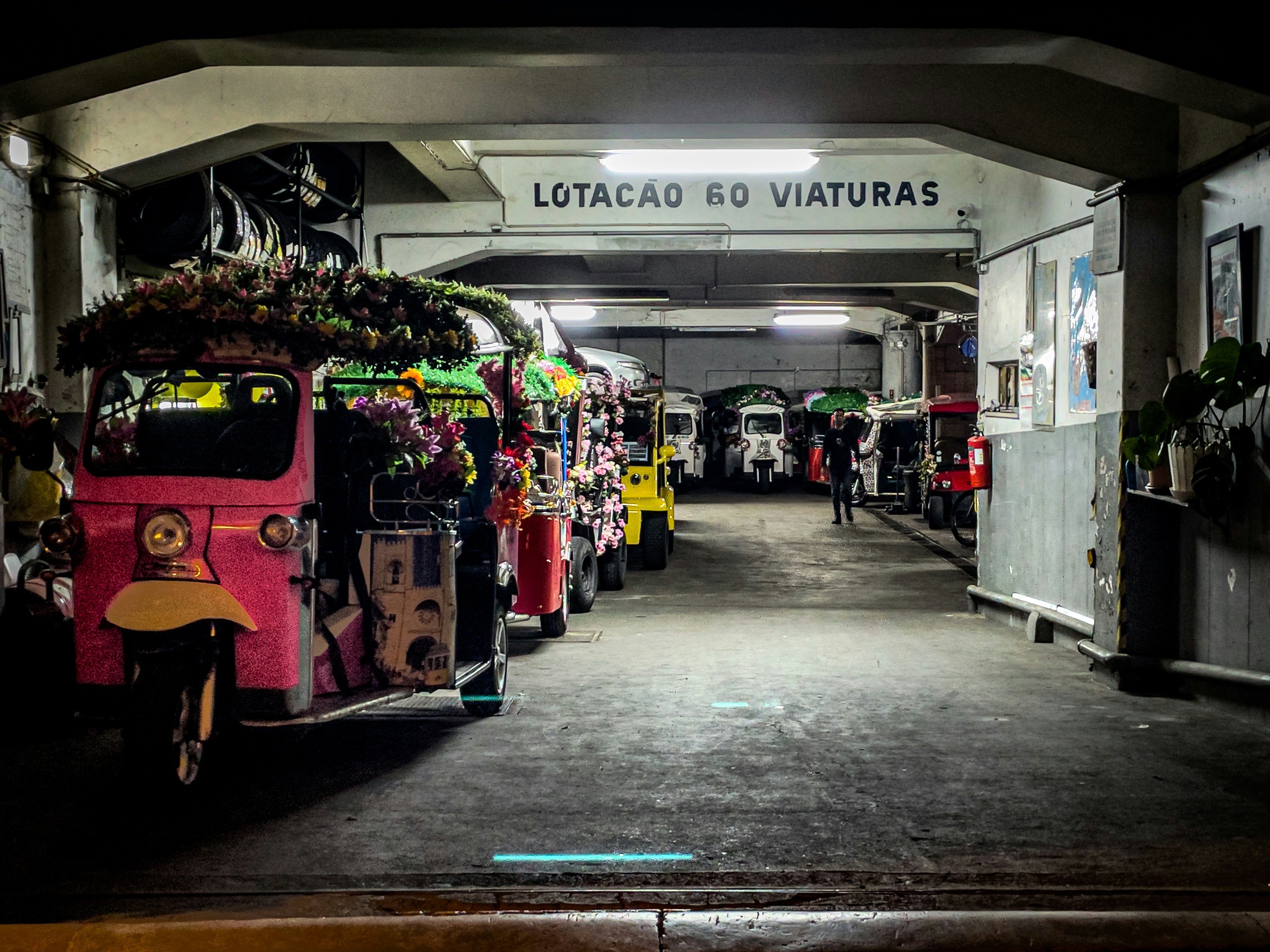 Colorful Tuk-Tuks under a Dim Underground Corridor
