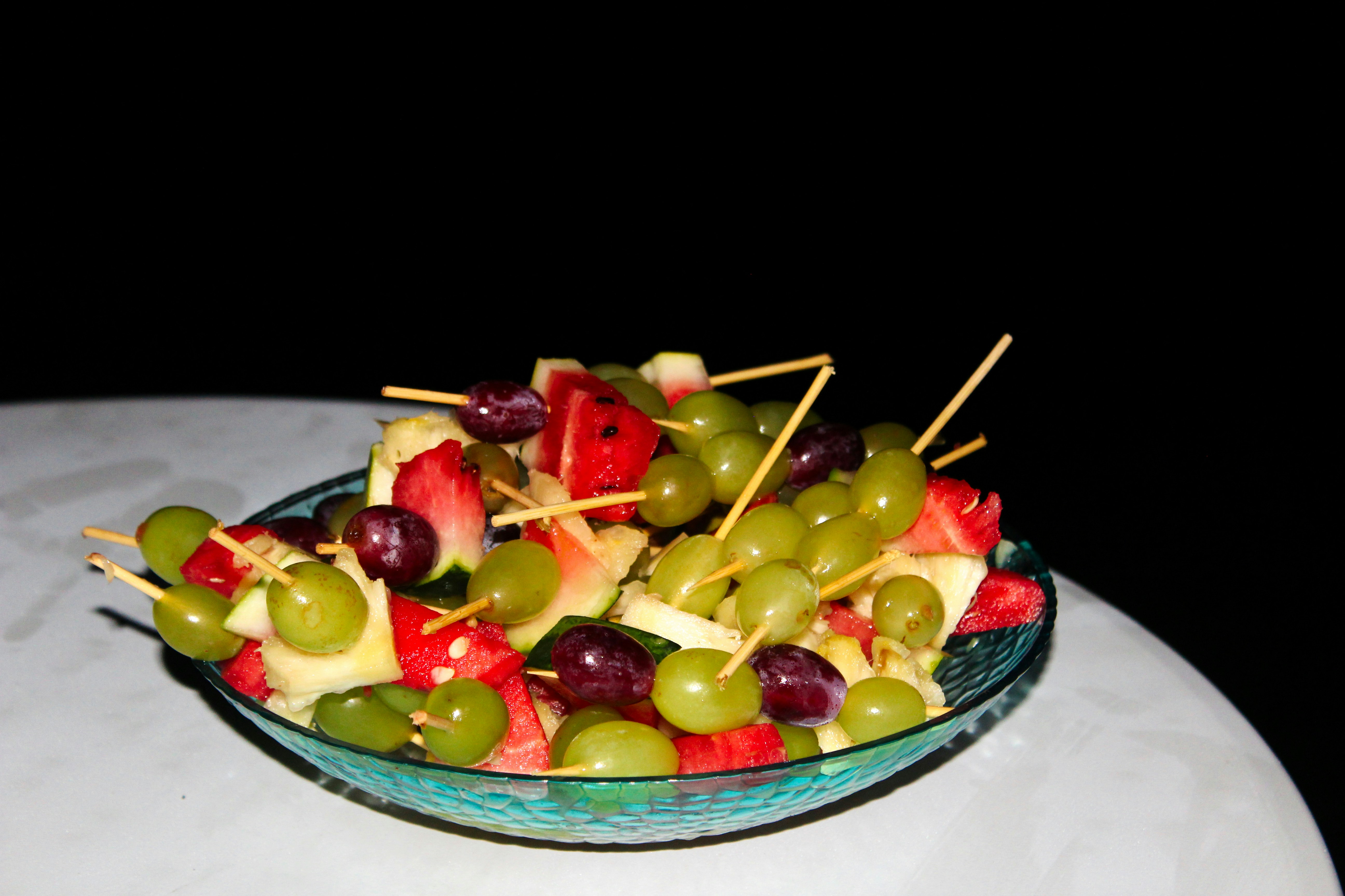 Skewered Orchard: A Colorful Burst of Fruit on a Marble Plate