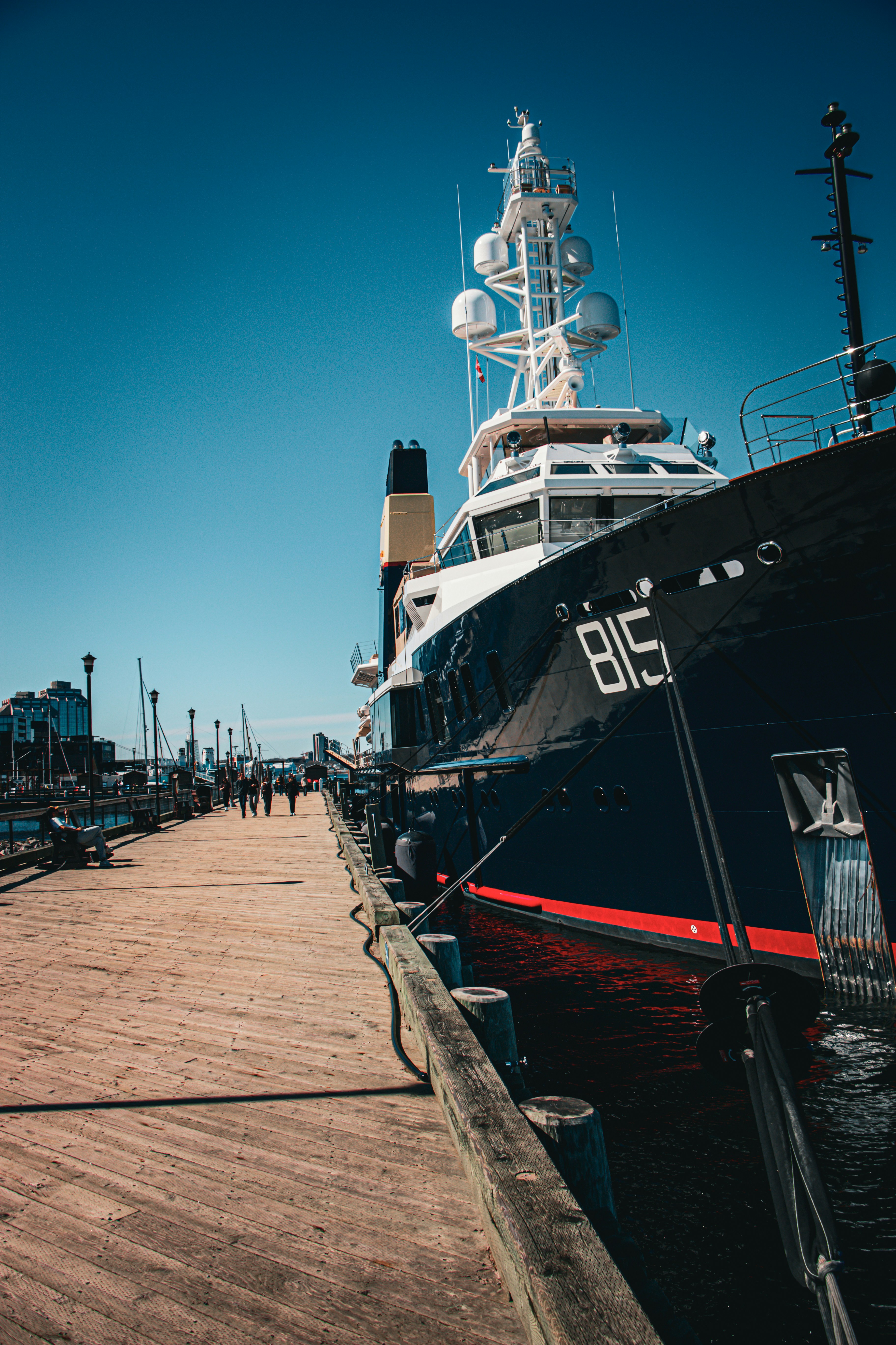 Harbor Giant: A Navy Vessel Berths Along a Sunlit Pier