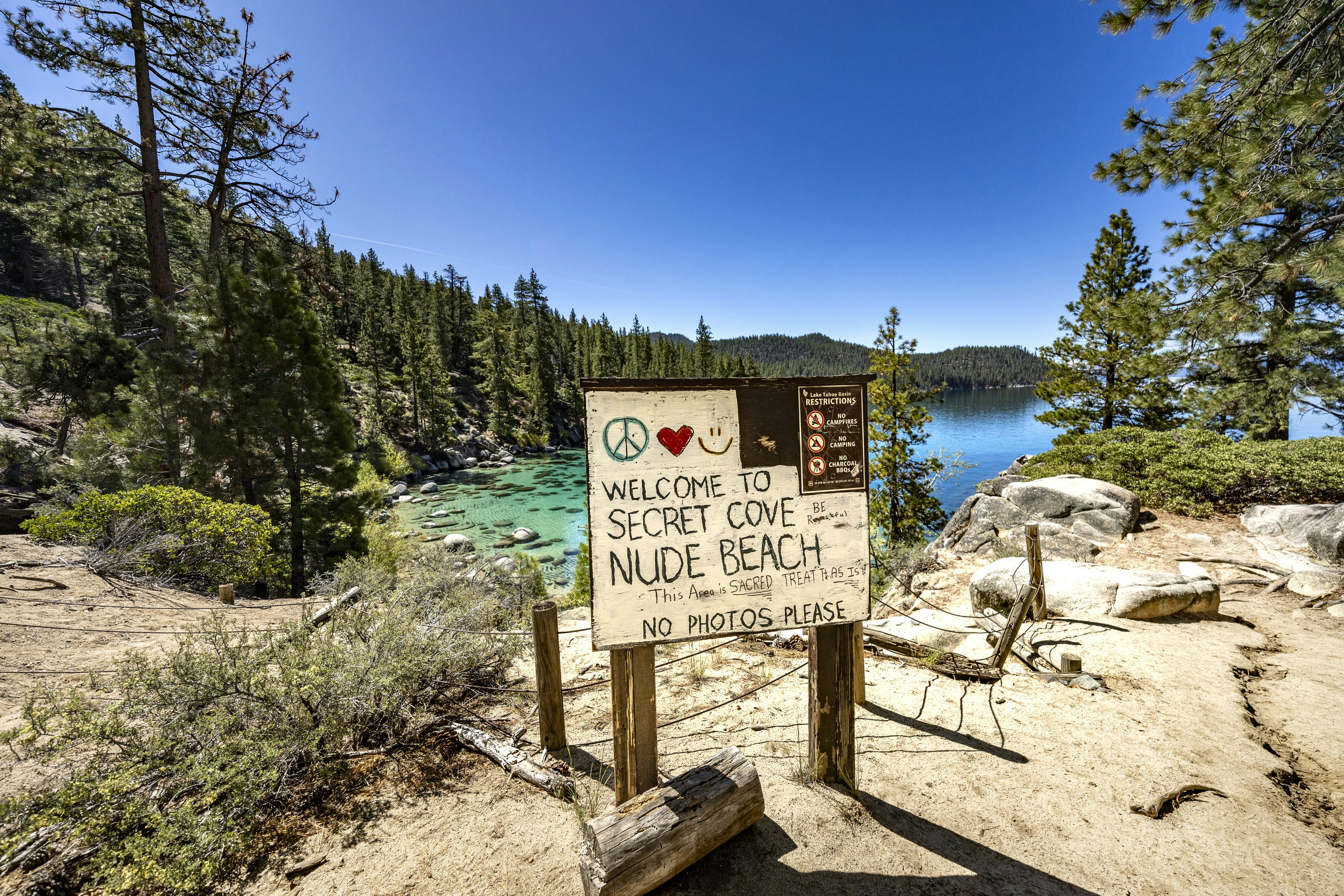 Secret Cove Nudist Beach Sign Silhouette by Turquoise Lake
