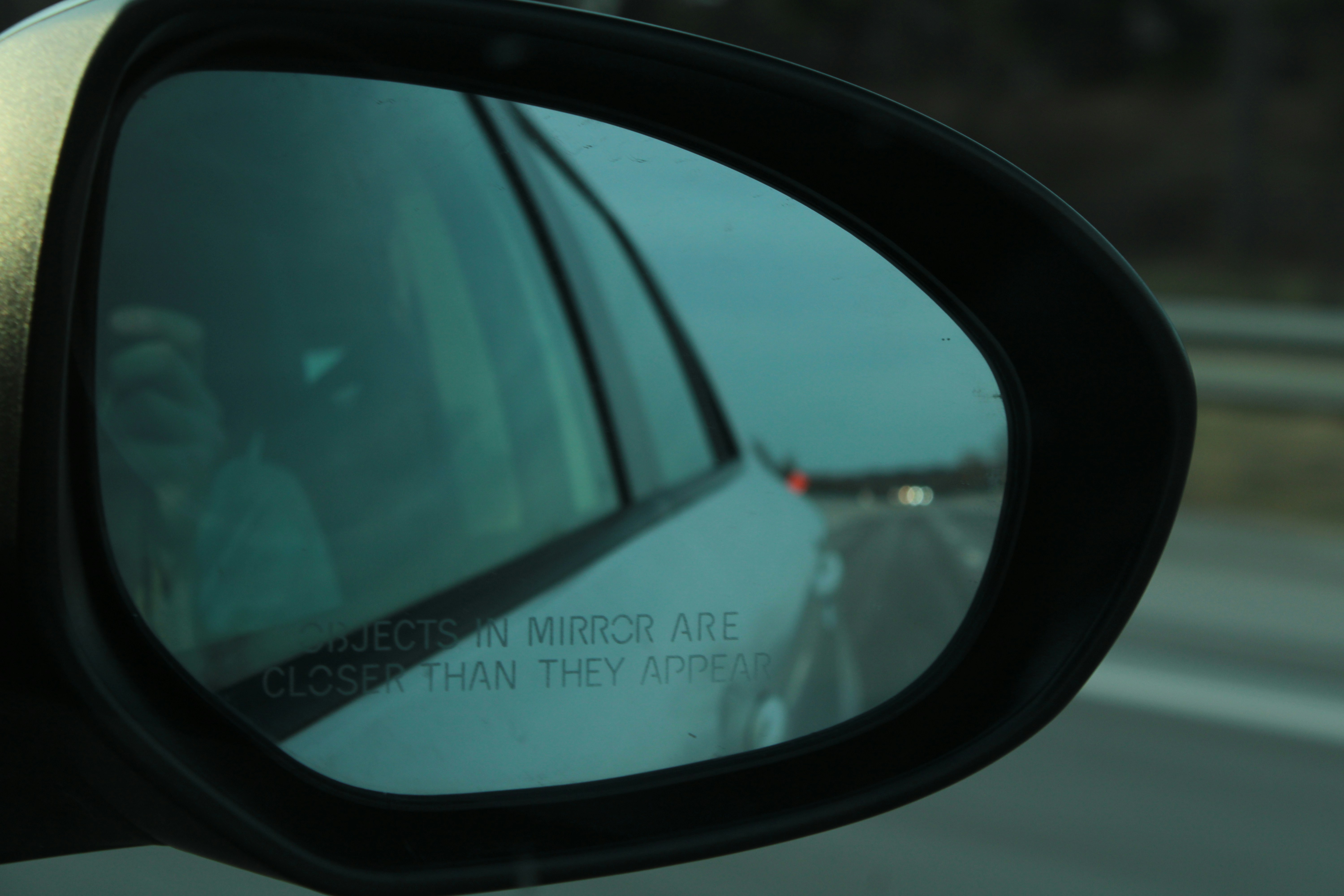 Side-View Echo: A Quiet Car Mirror Reflecting Highway Motion