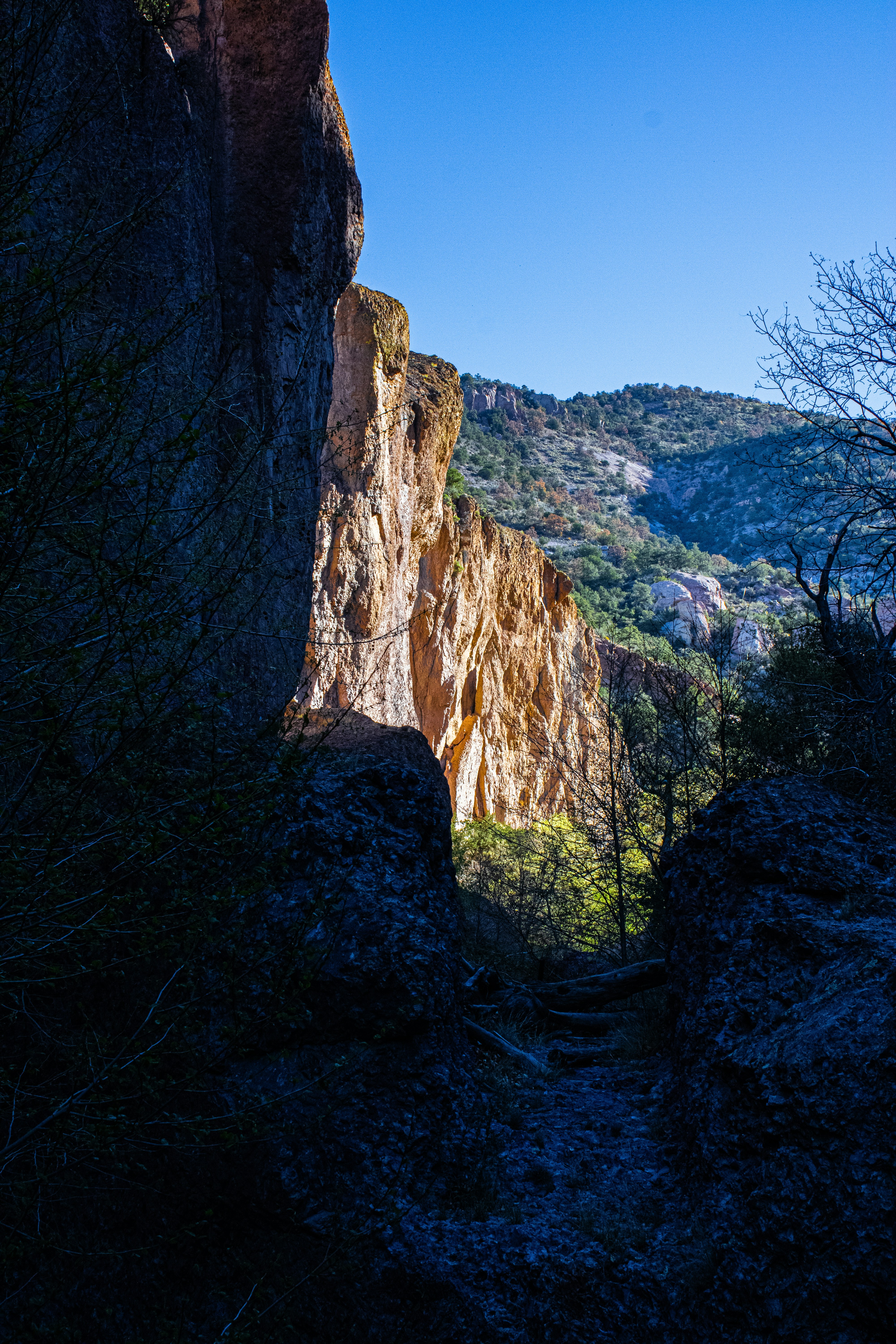 Sunlit Cliff Corridor: A Walled Path Through Golden Rock Faces