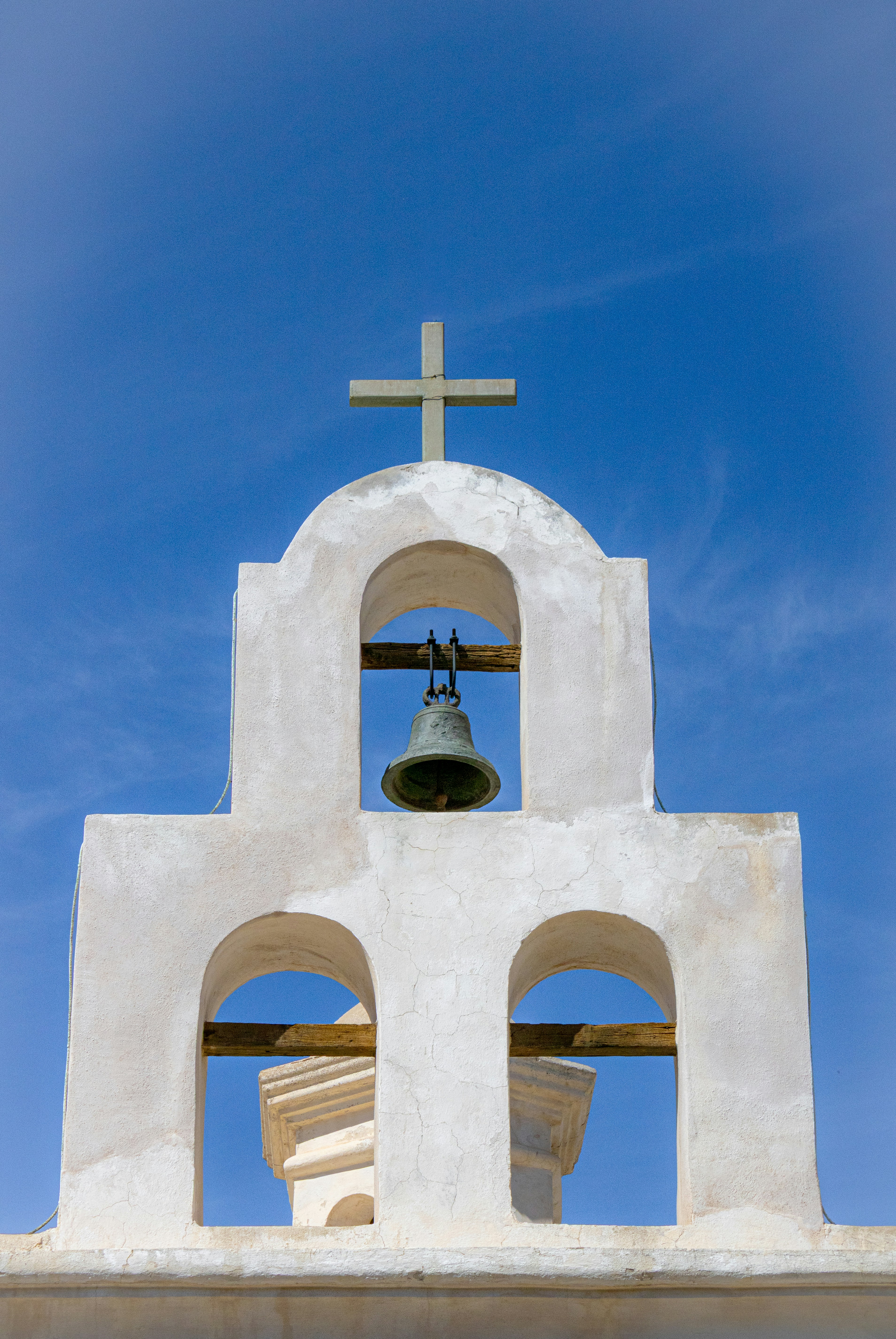 Bell Tower in Blue: A Santorini‑like White Church Crowned by a Cross