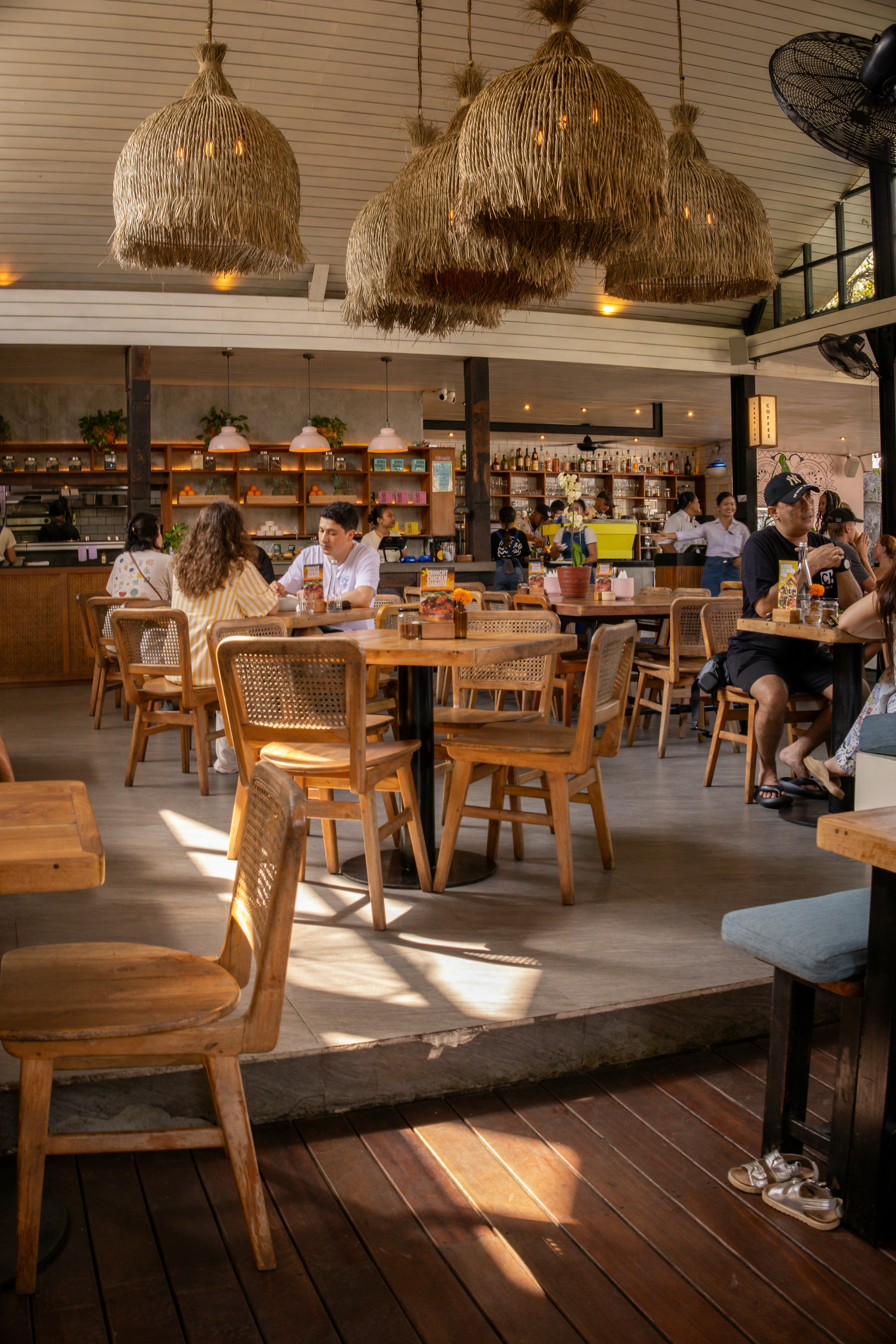 Sunlit Café Conversations Under Wandering Palms