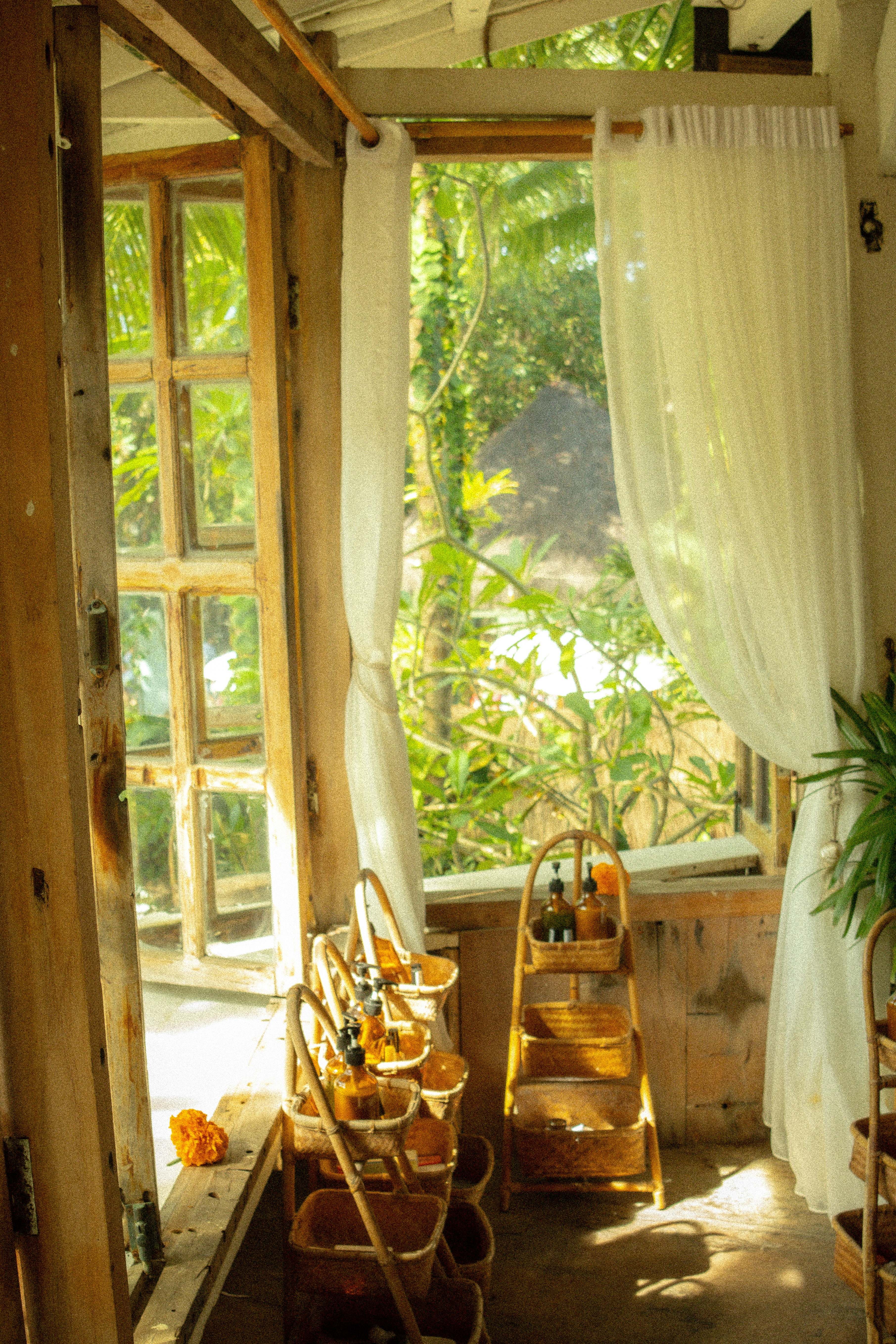 Sunlit rustic veranda with wicker baskets and sheer curtains