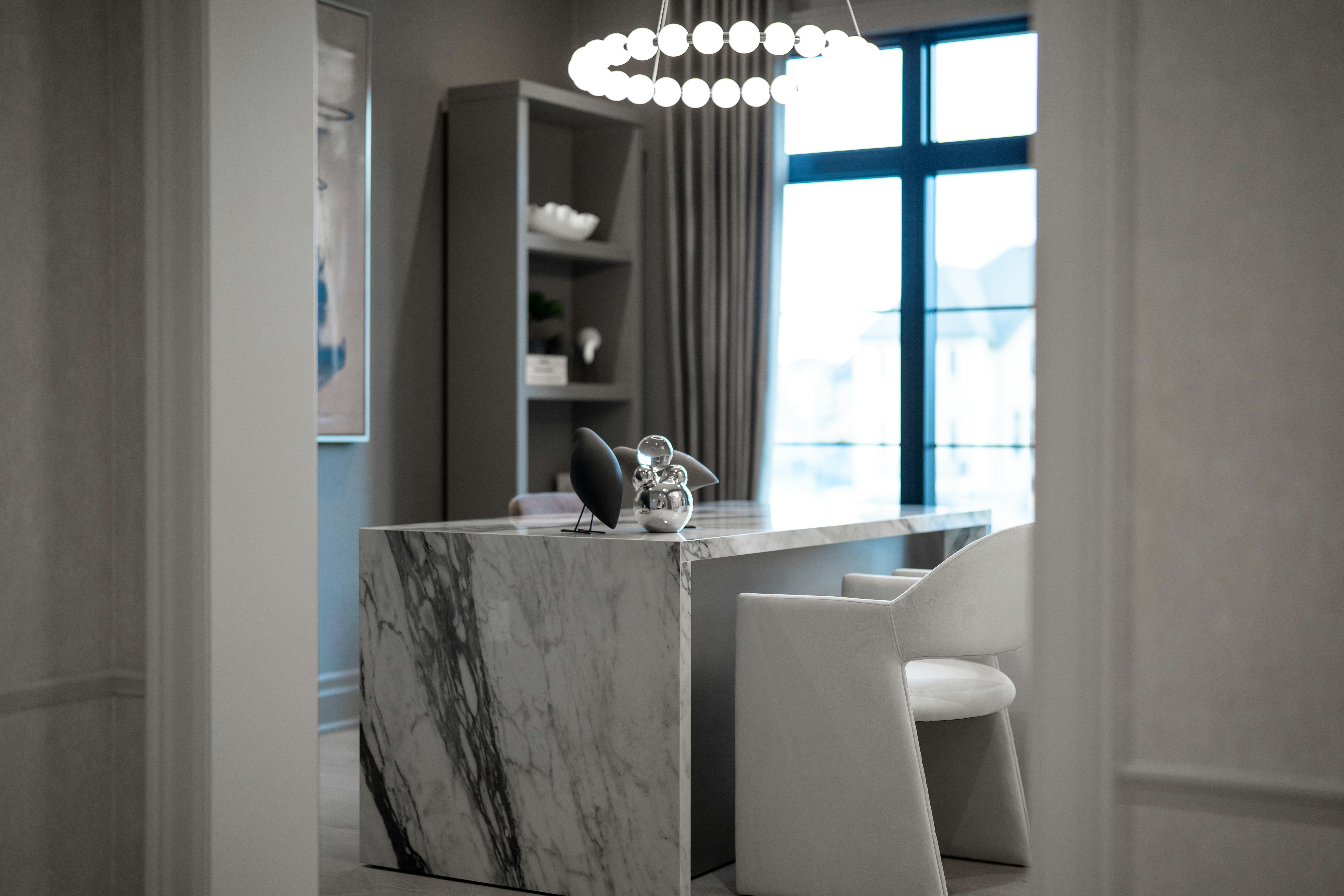 Marble Front Desk in Softly Lit Contemporary Lobby