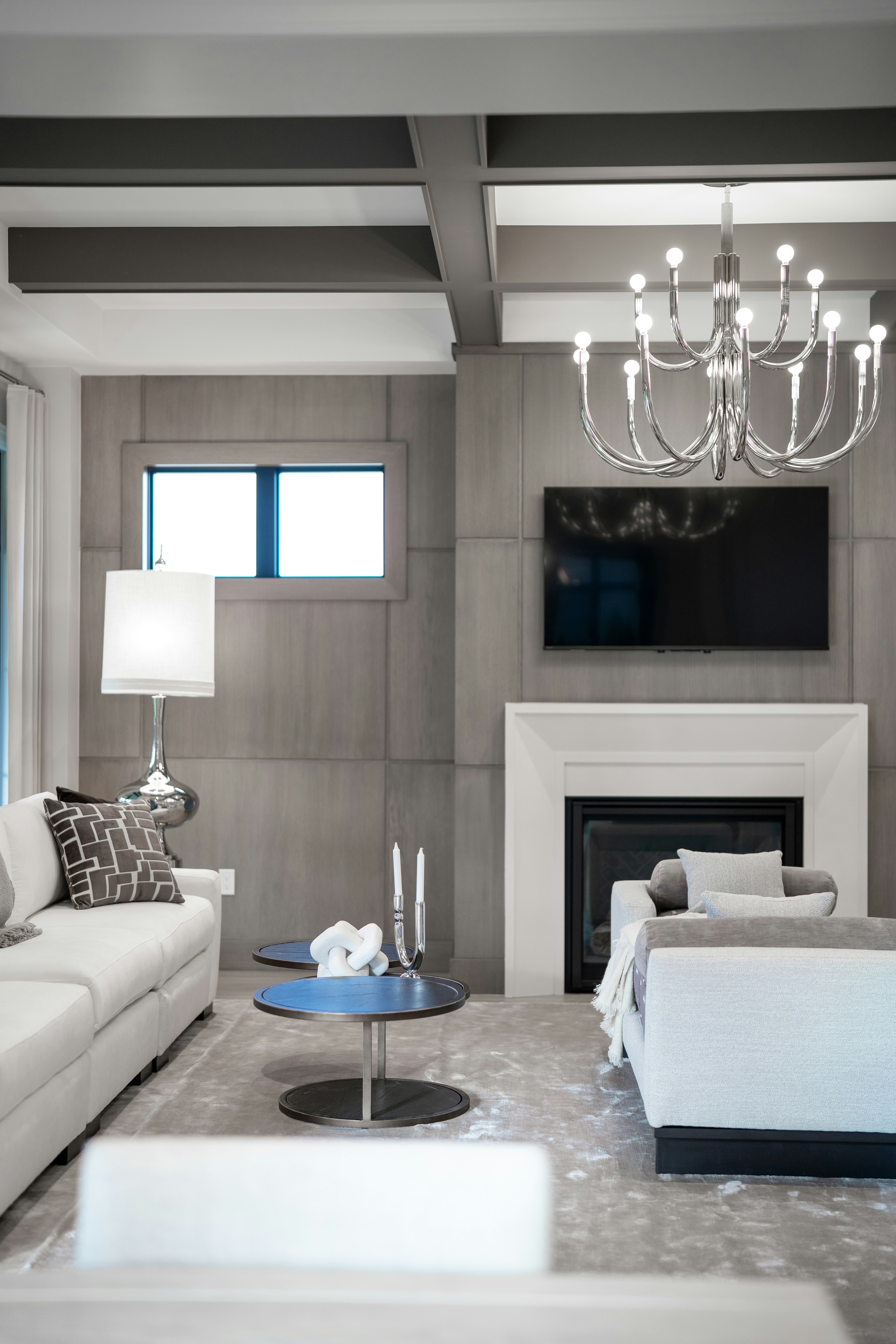 Minimalist Luxe: A Sunlit Living Room with Modern Fireplace and Chandelier