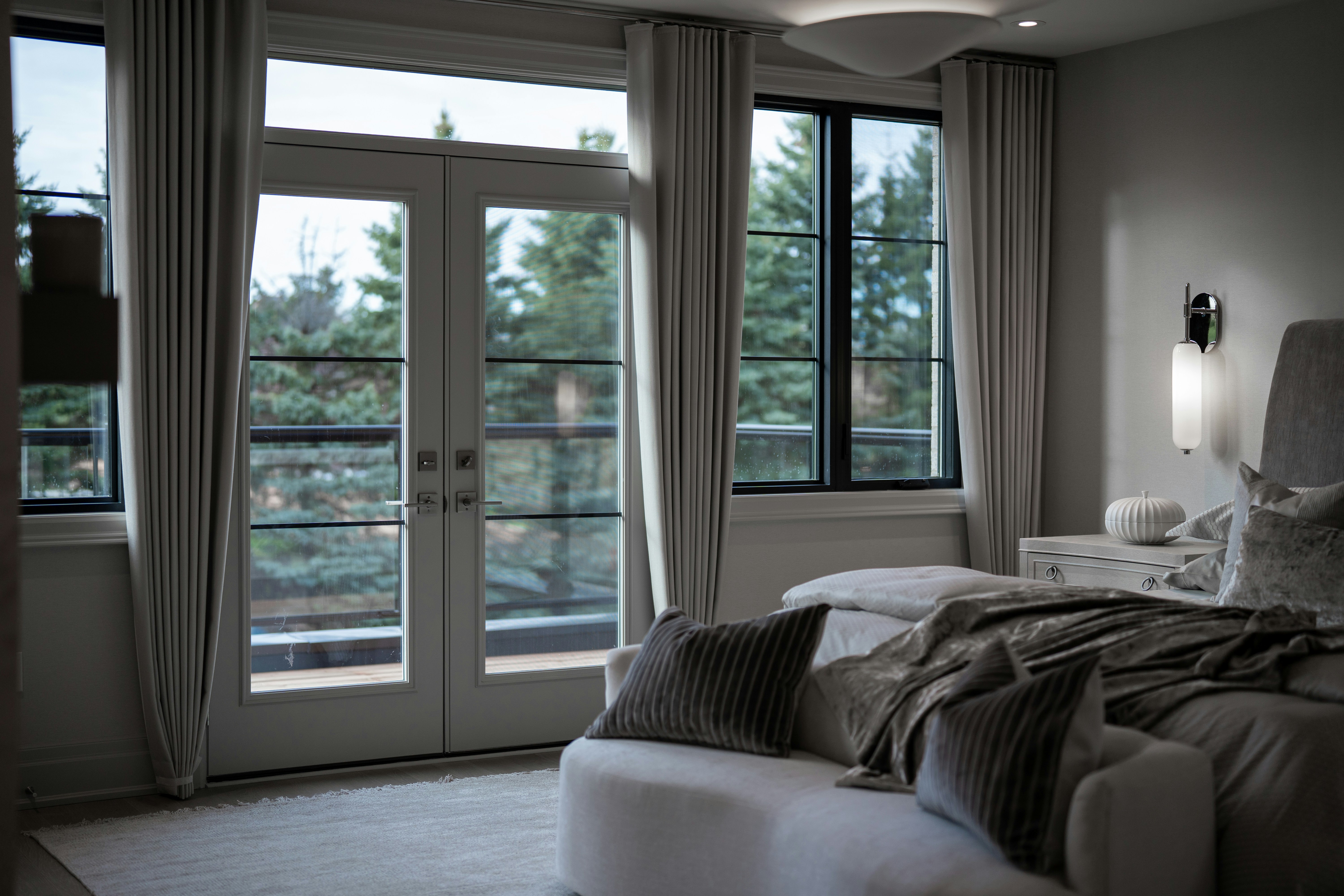 Cozy Bedroom with Natural Light Streaming Through French Doors