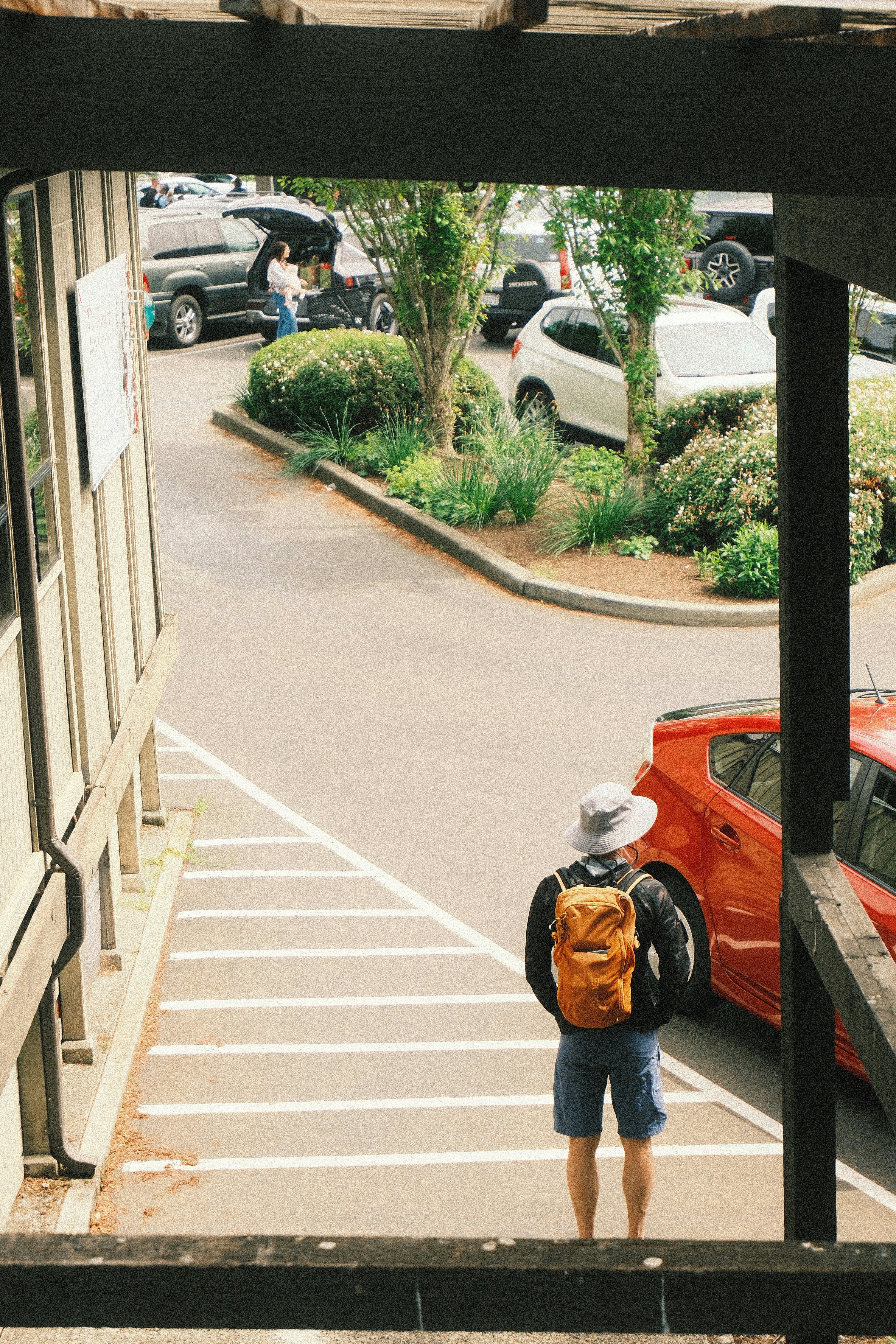 Backpacker at the Corner Staircase: A Quiet Moment Between Parking and Path