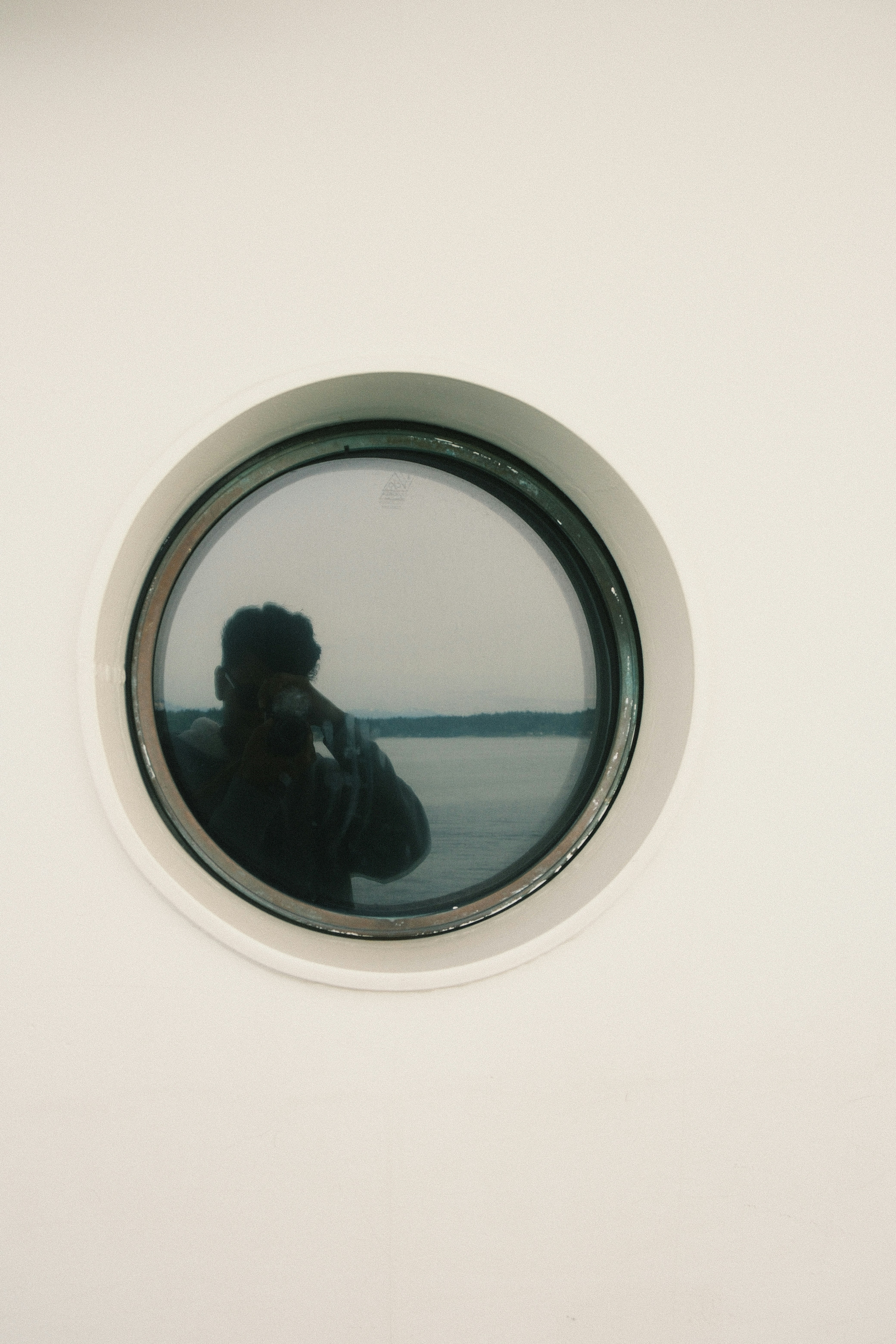 Circular Window Portrait: Reflections on a Quiet Port