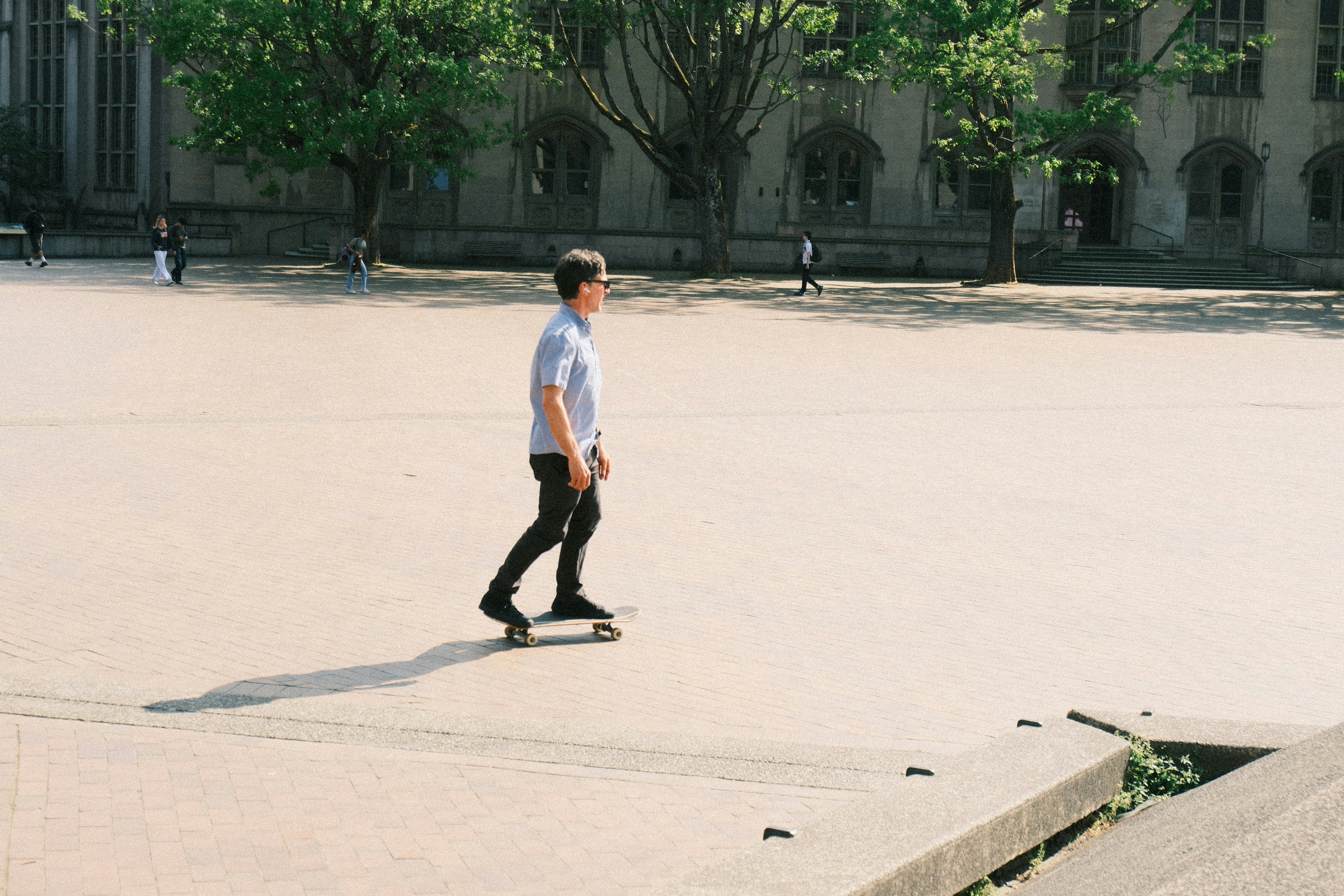 Skateboarder in a Quiet Campus Square