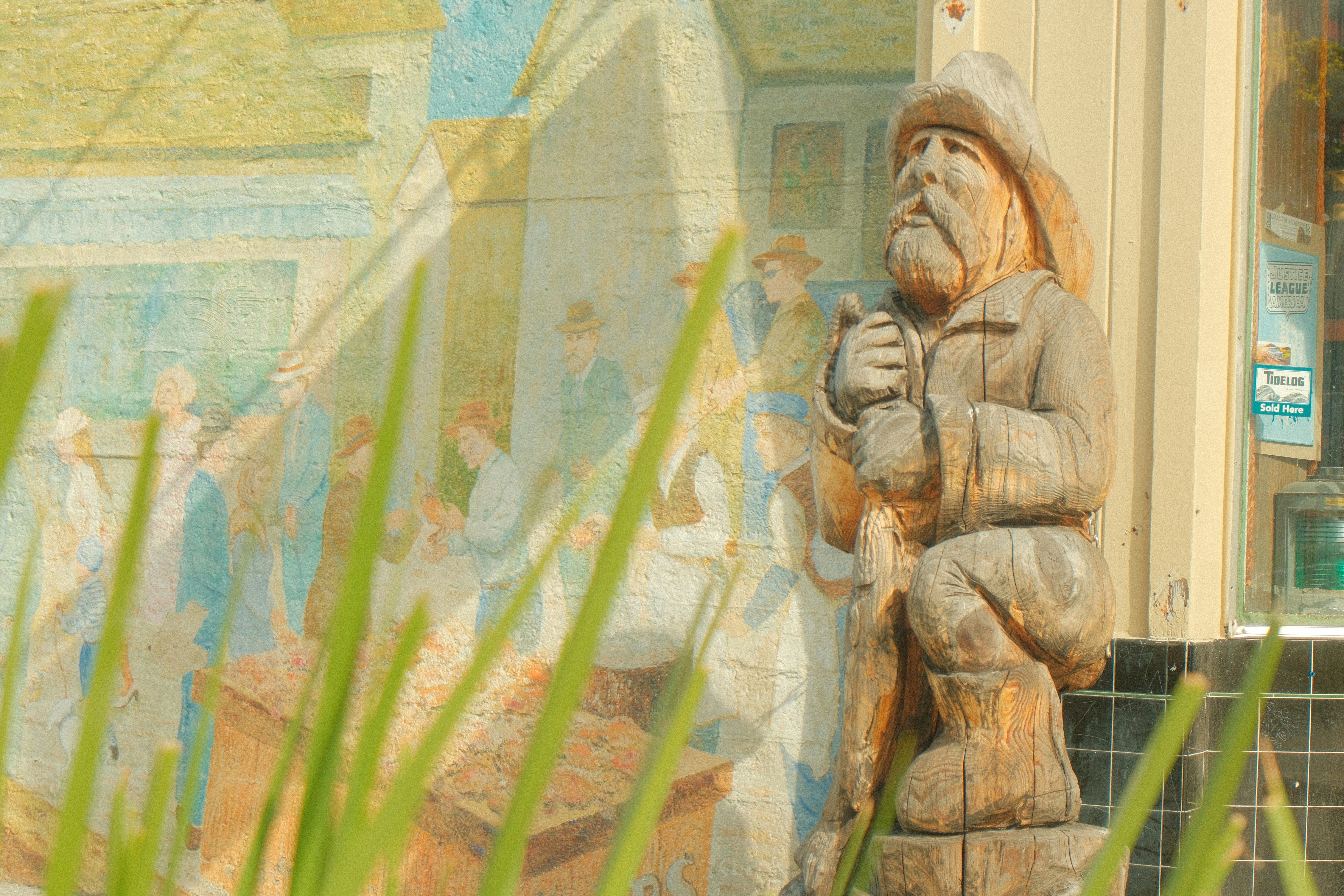 Woodland Guardian by the Porch: A carved figure watches over a mural scene