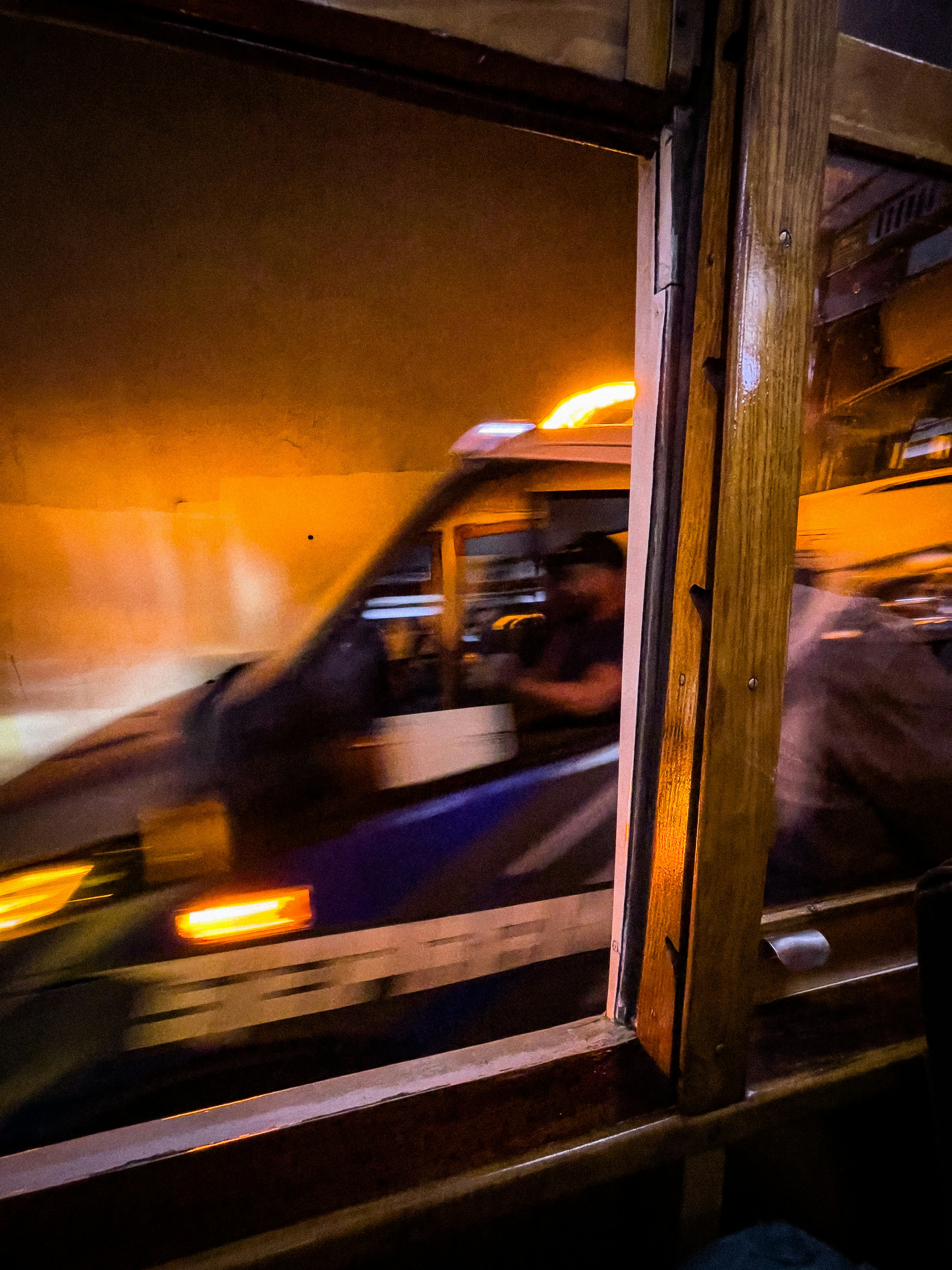 Motion at the Window: Night Shift with a Blurred Ambulance in Scene