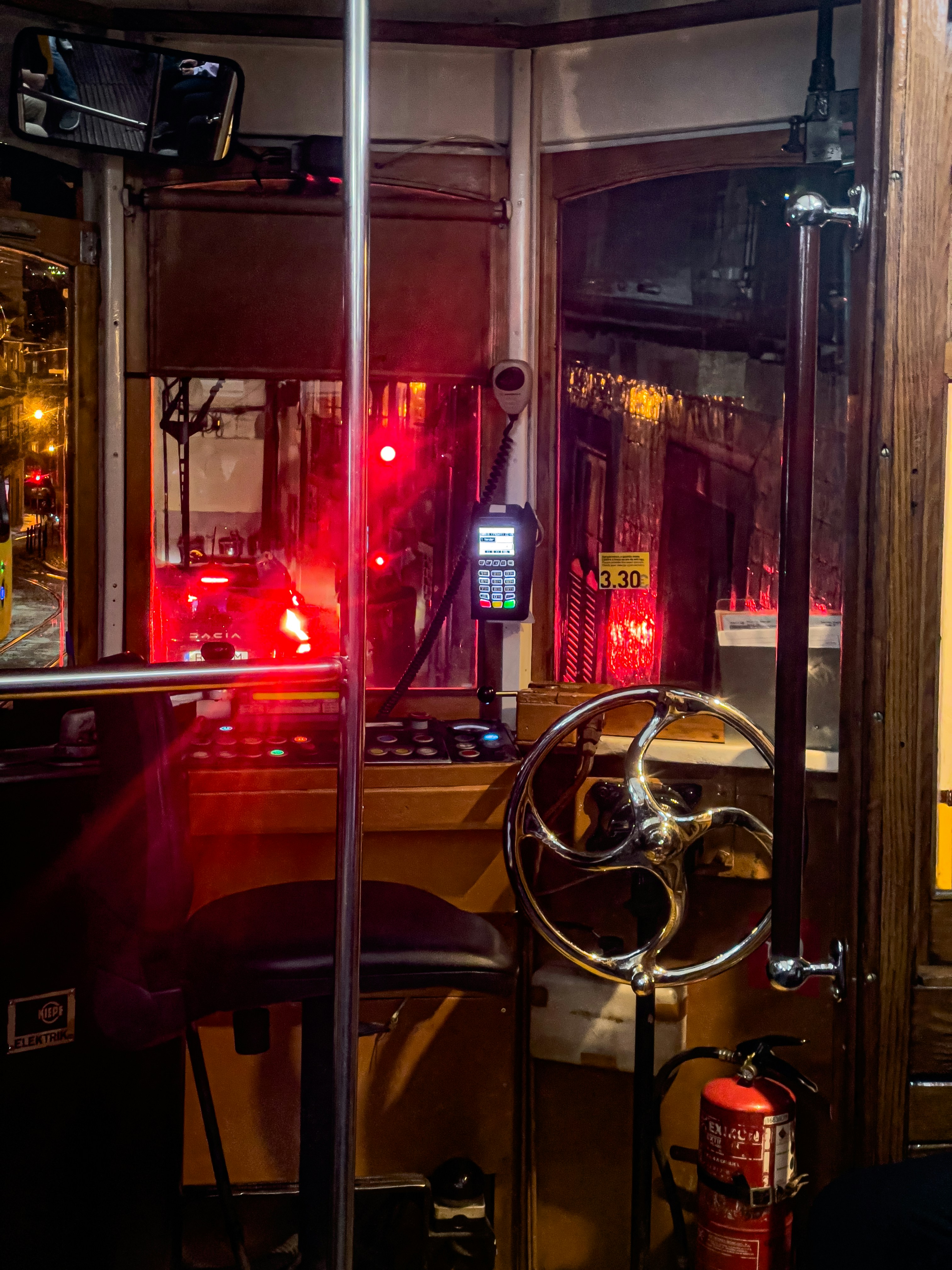 Red Cab Lights Reflected in a Vintage Bus Cab
