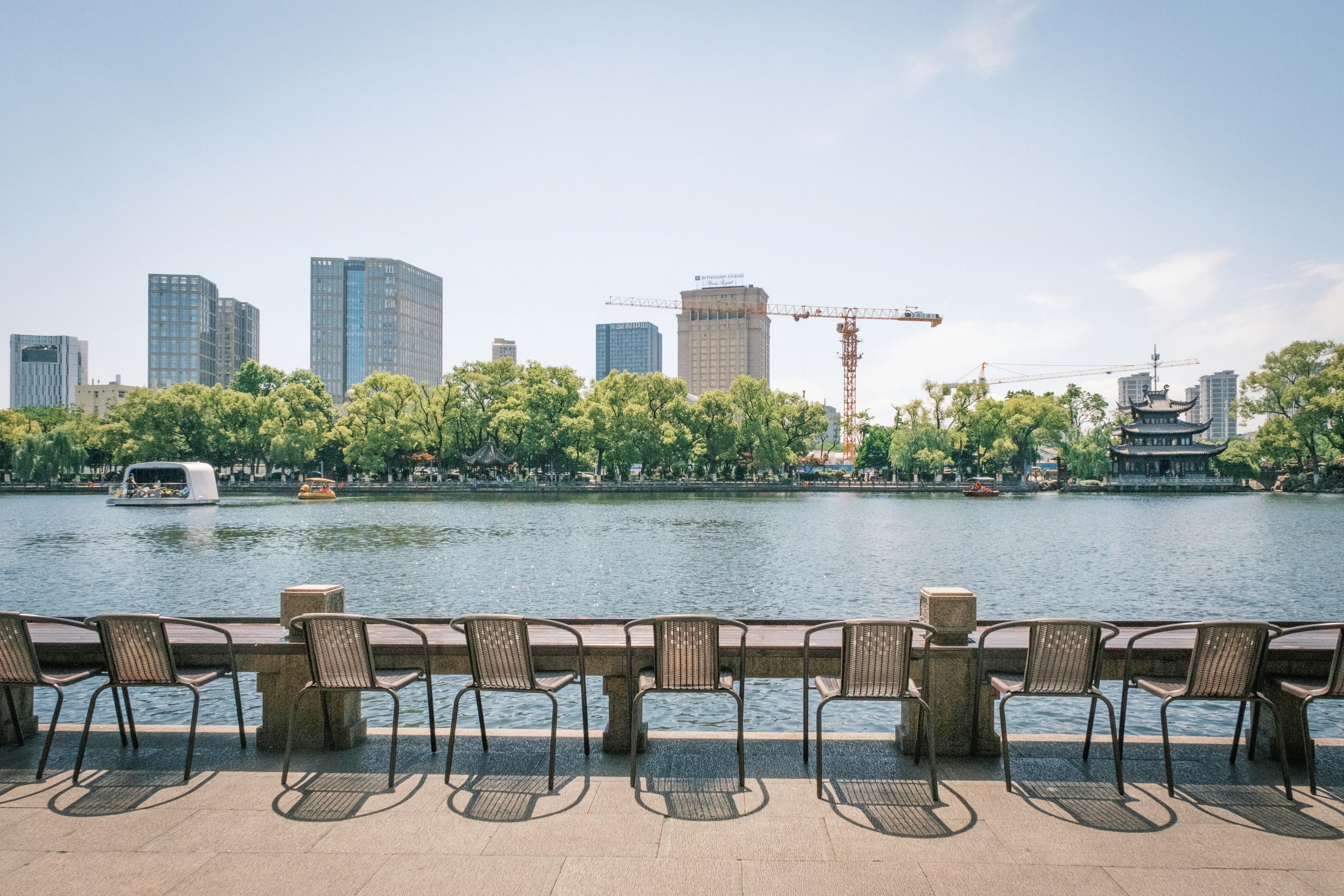 Row of Empty Benches Overlooking a Riverfront Cityscape
