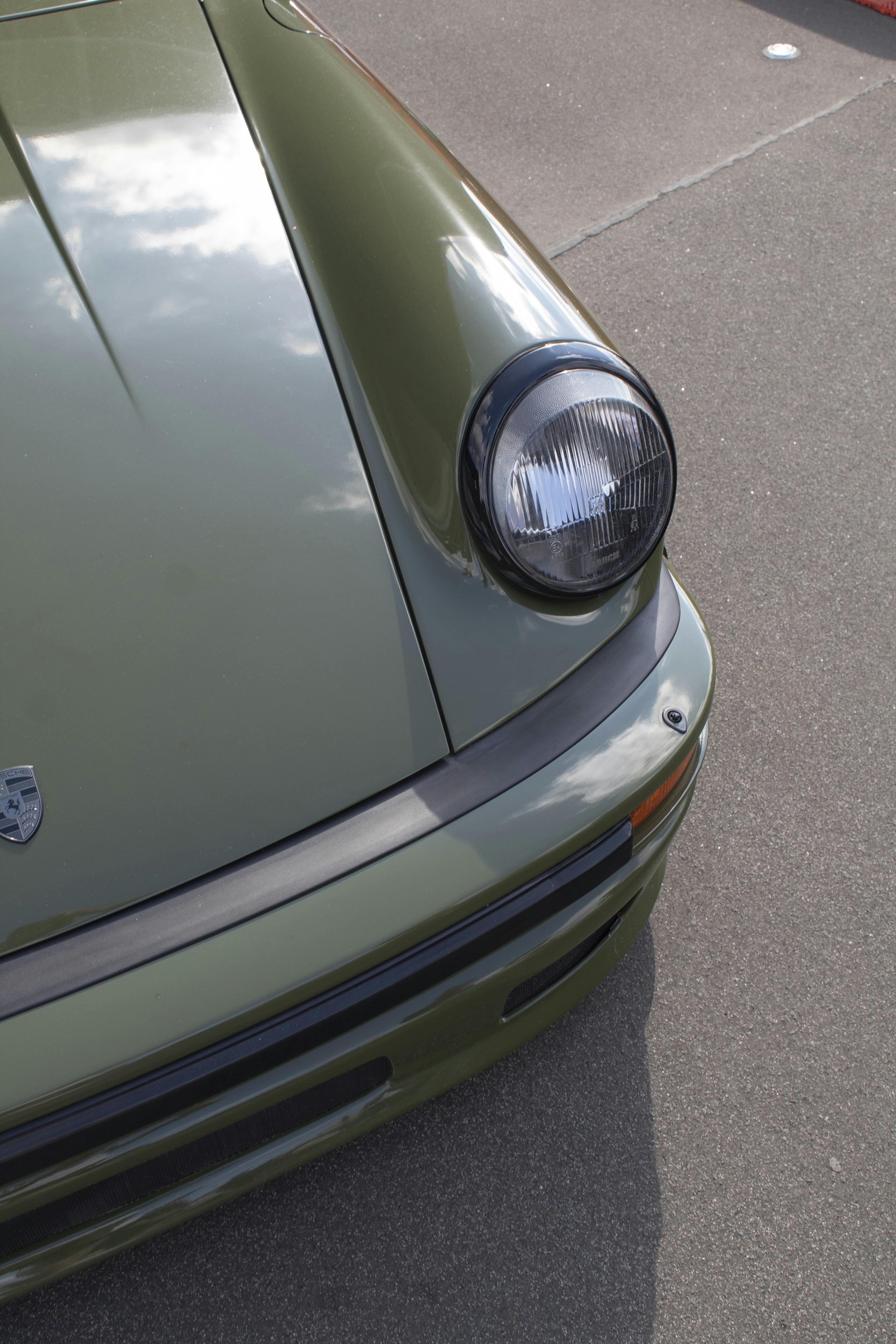 Olive Green Classic: The Front Quarter of a Vintage Porsche