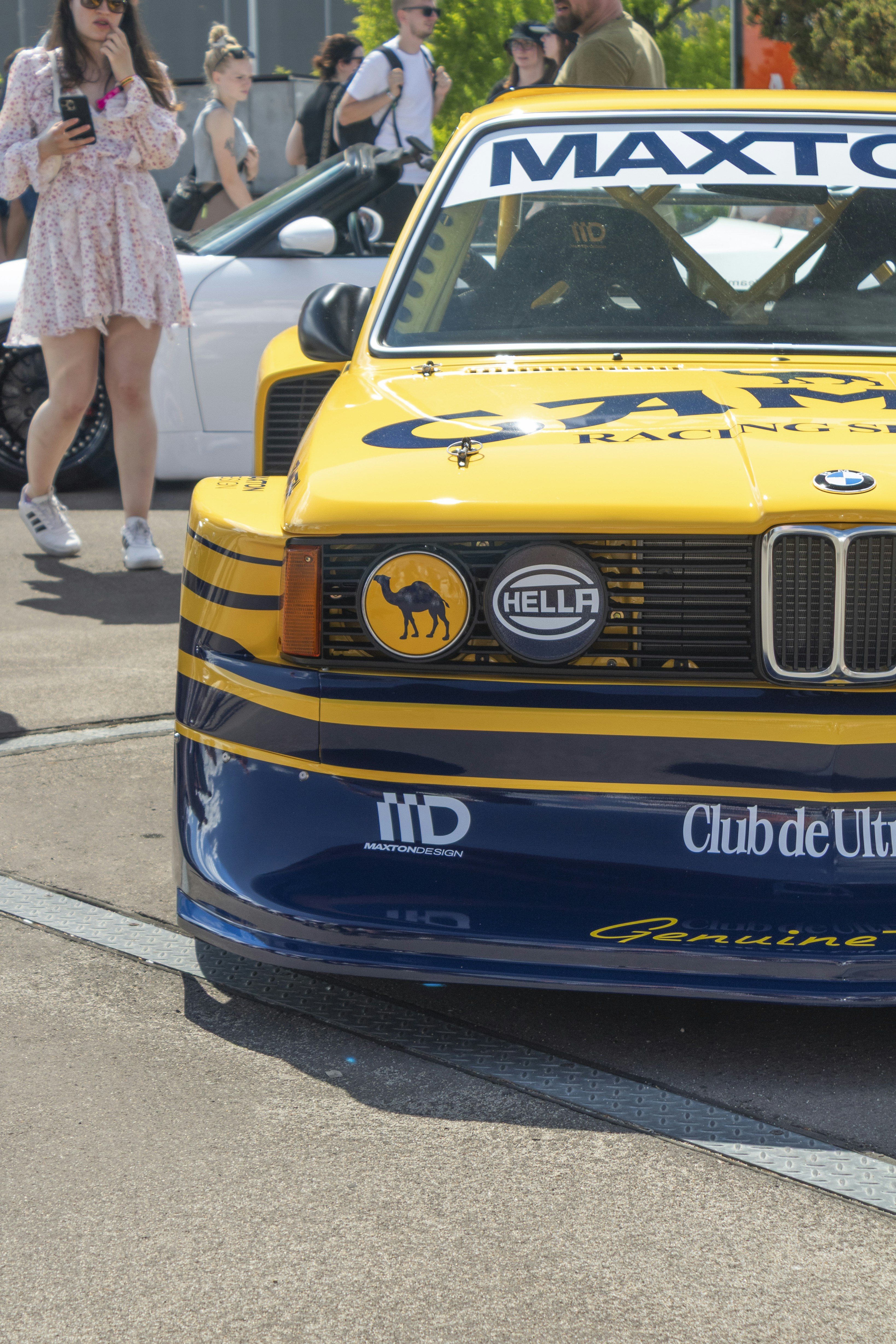 Yellow Racing Glory: Front-Staged BMW with Attentive Crowd